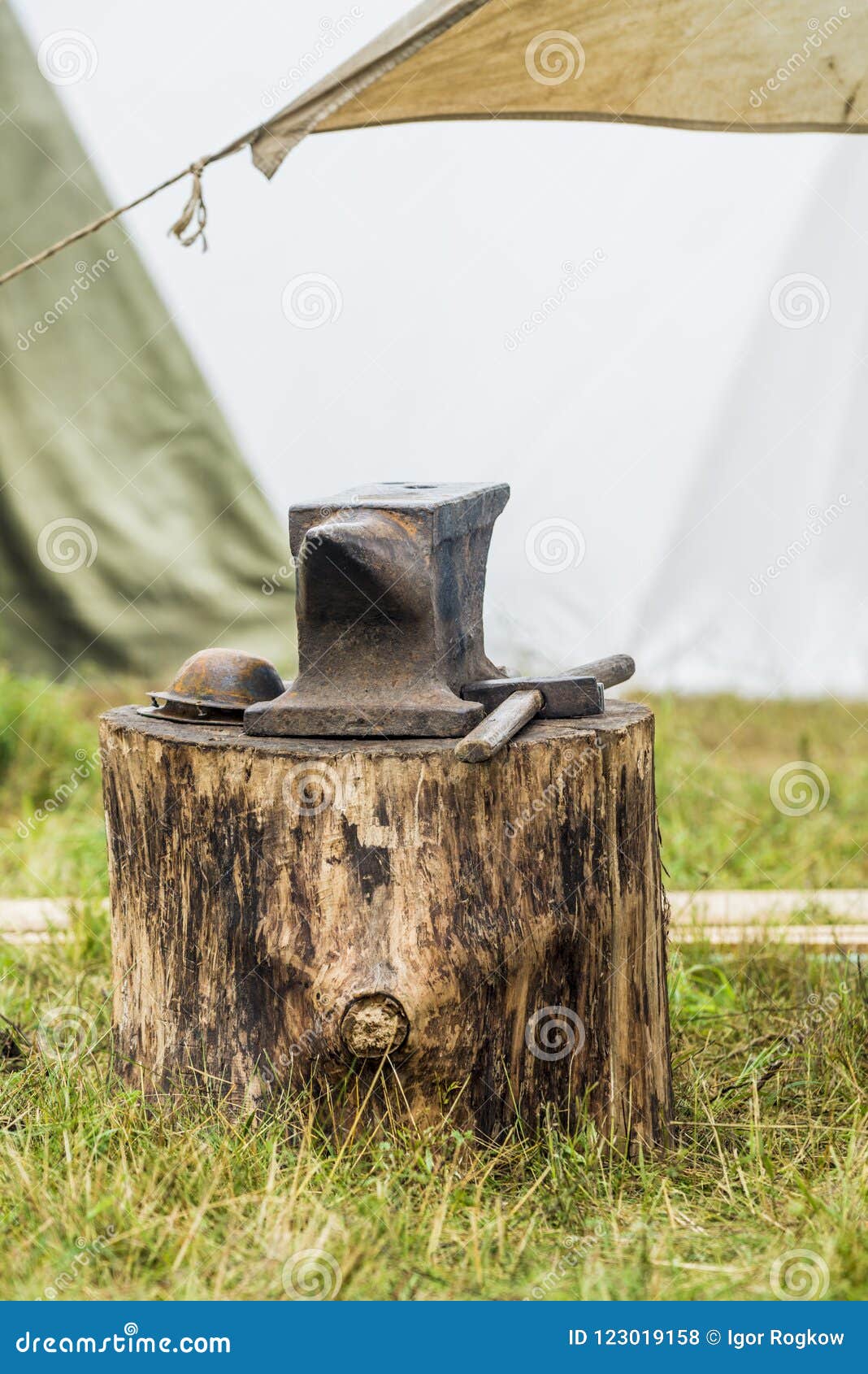 Ancient Forge Anvil and a Hammer on the Stump. Forge Under the Open Sky ...