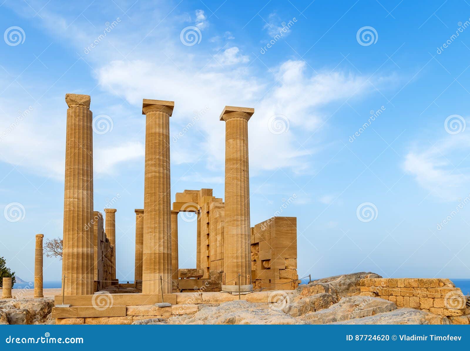 Ancient Greek Pillars at Lindos Acropolis with Blue Cloudy Sky in the ...