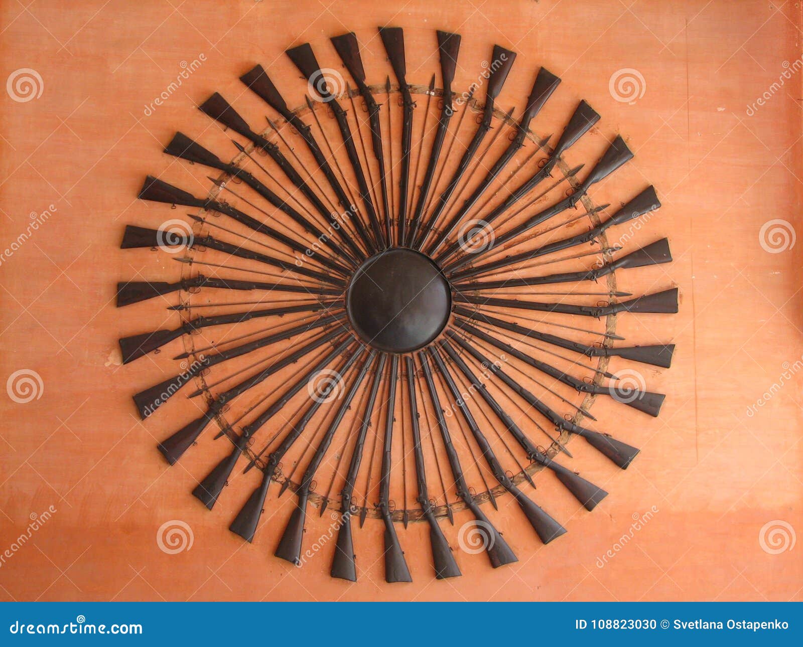 The Ancient Guns, Stacked in a Circle, Hang on the Wall of Orange Stock ...