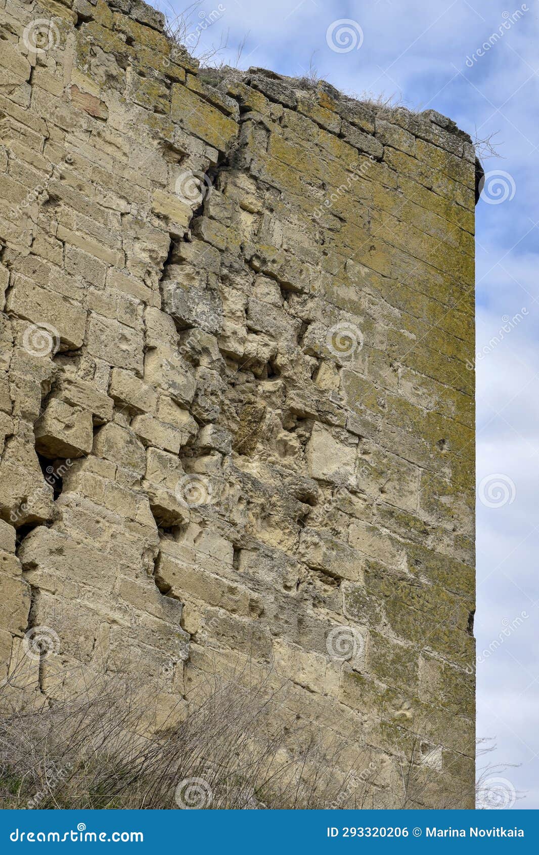 An Ancient Moss-covered Stone Wall with Deep Cracks and Collapsed ...