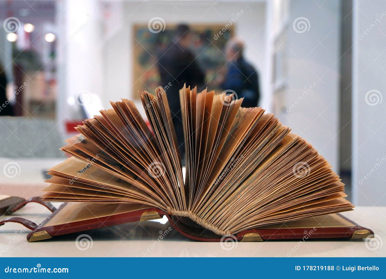 Ancient Open Book with Two People Standing in the Background Stock ...