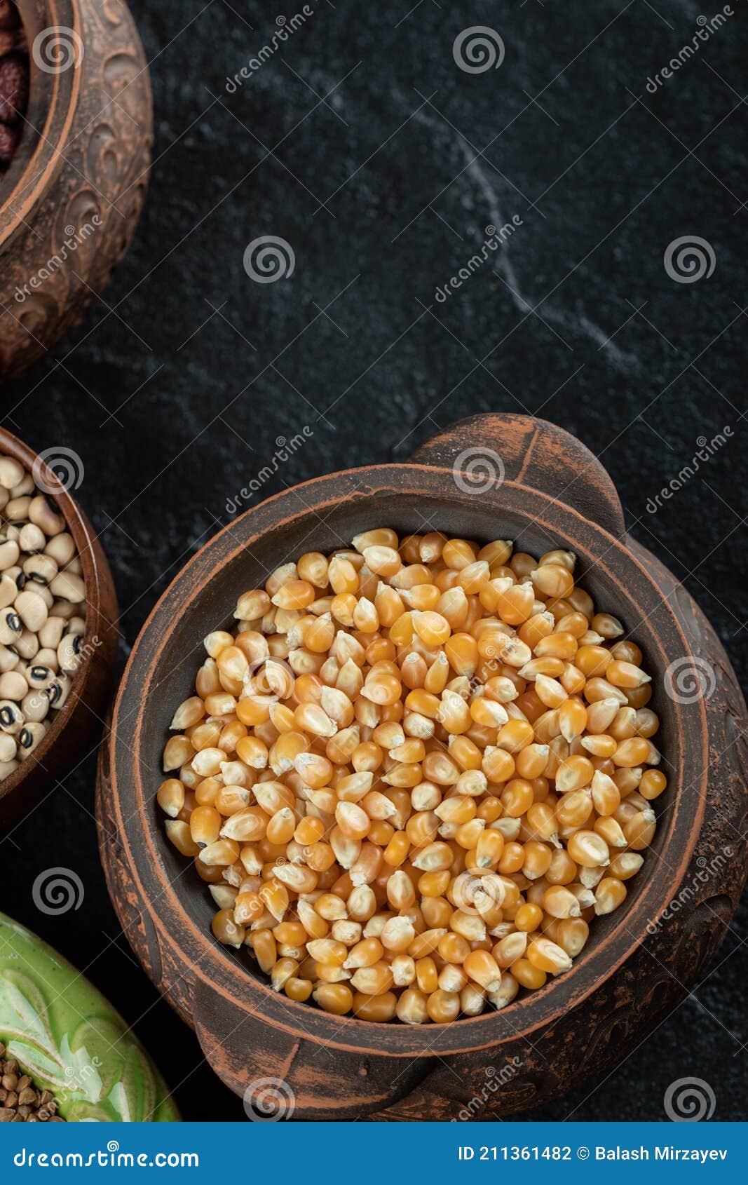 An Ancient Pot with Uncooked Popcorn on a Dark Background Stock Photo ...