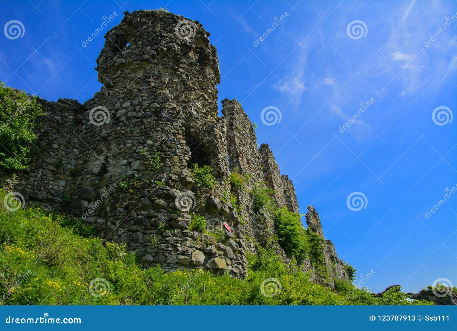 The Ruins Of Khust Fortress On A Hill In The Middle Of A Typical ...