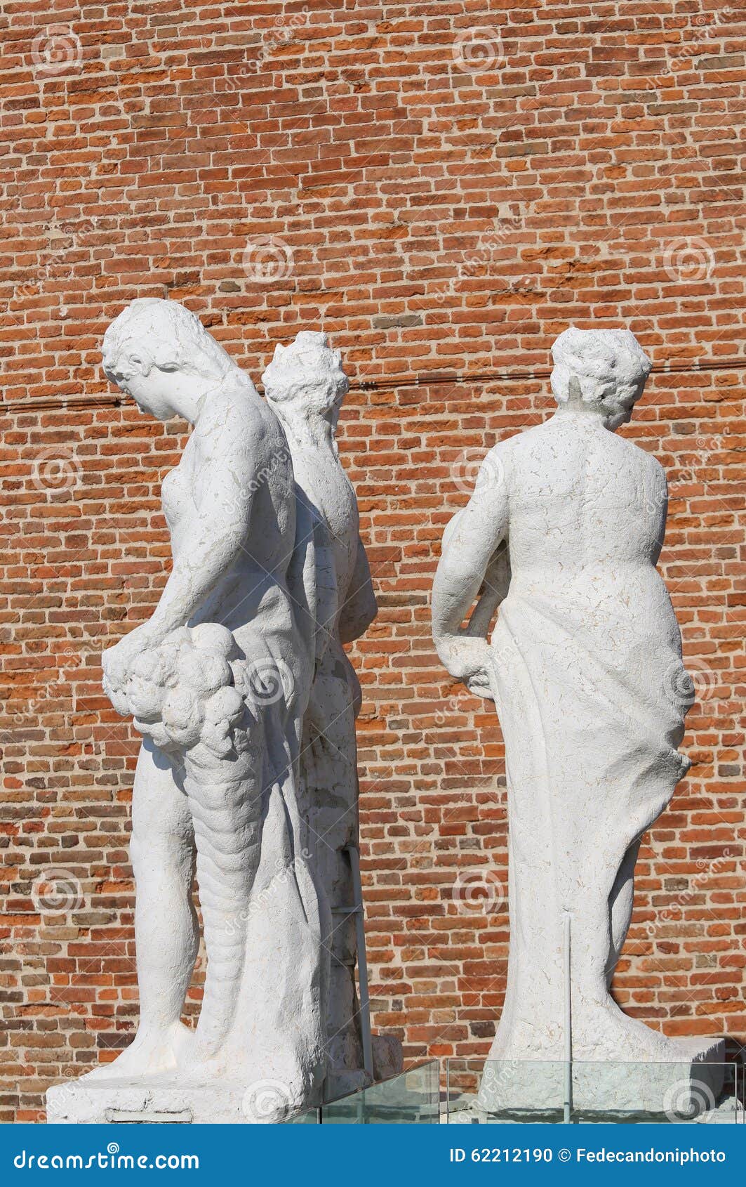 Ancient Statues with the Background Red Brick Wall Stock Photo - Image ...