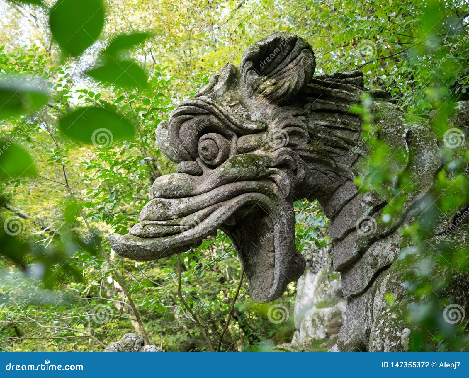 An ancient stone dragon stock photo. Image of trees - 147355372