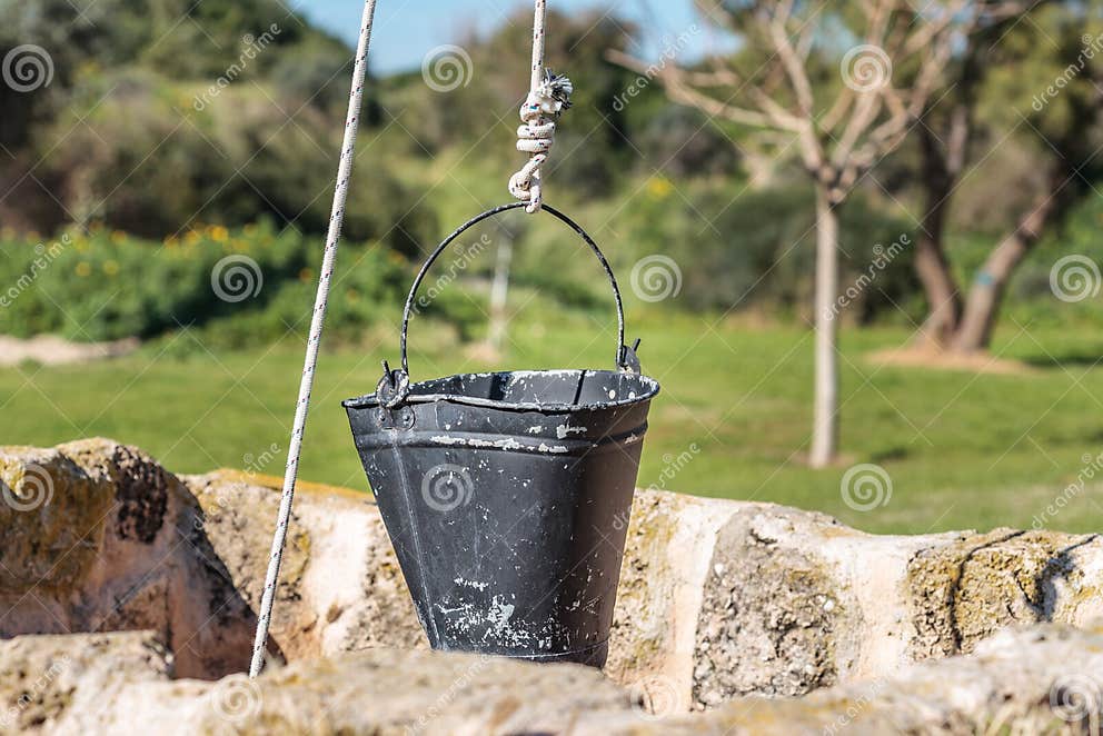 Ancient Water Well with a Bucket Stock Photo - Image of vintage ...