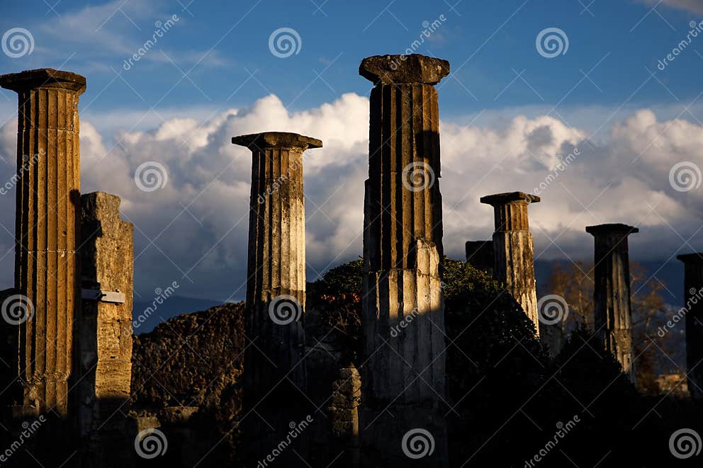An Ancient, Weathered Columns Standing Tall Against a Dramatic Sky ...