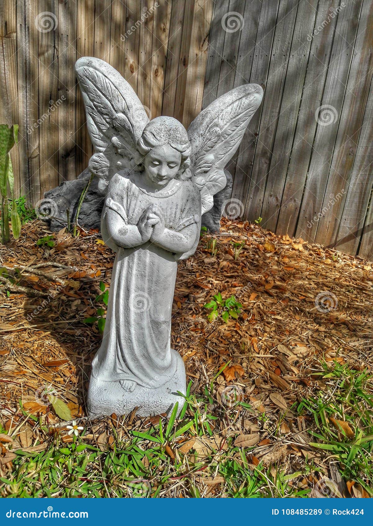 Angel statue stock image. Image of backyard, fence, grass - 108485289