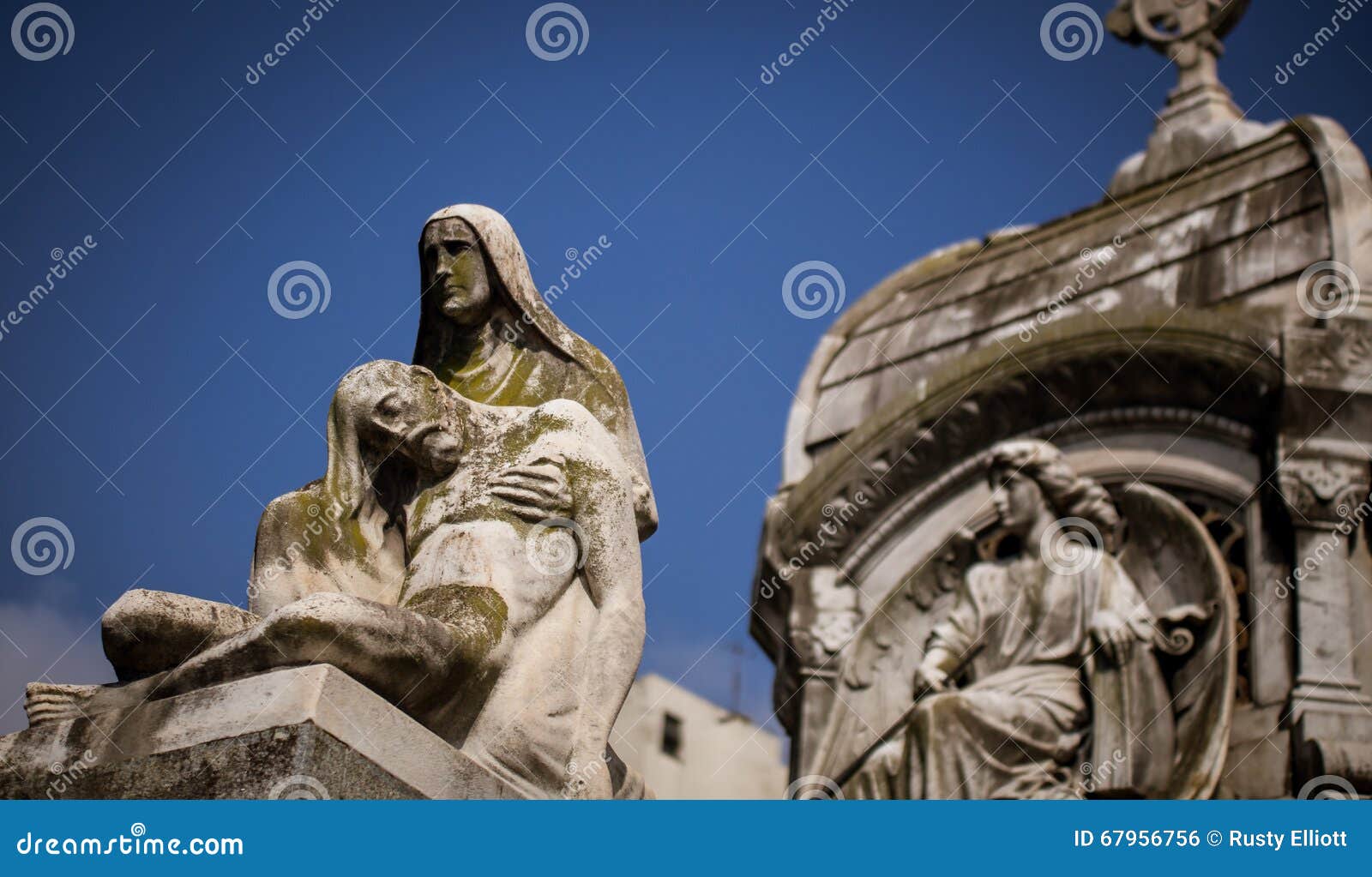 Angel holding a man statue stock photo. Image of religious - 67956756