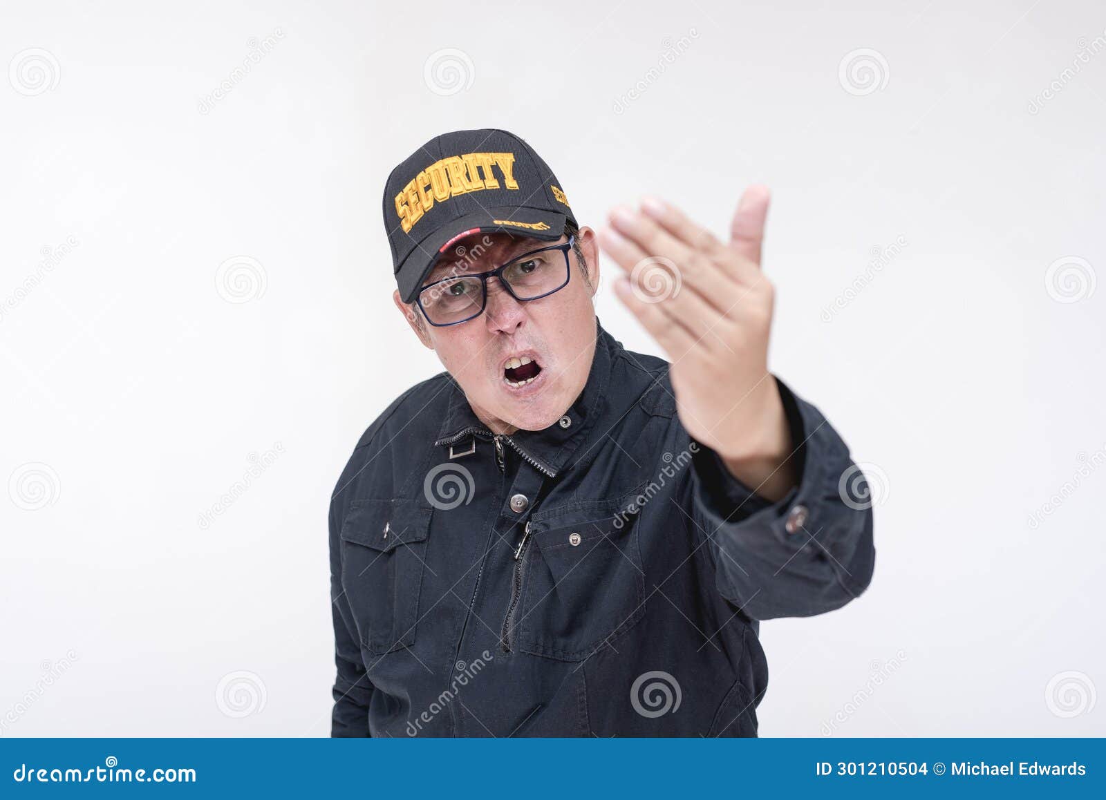 An Angered Security Guard Challenges Someone To Come Closer. Commanding ...