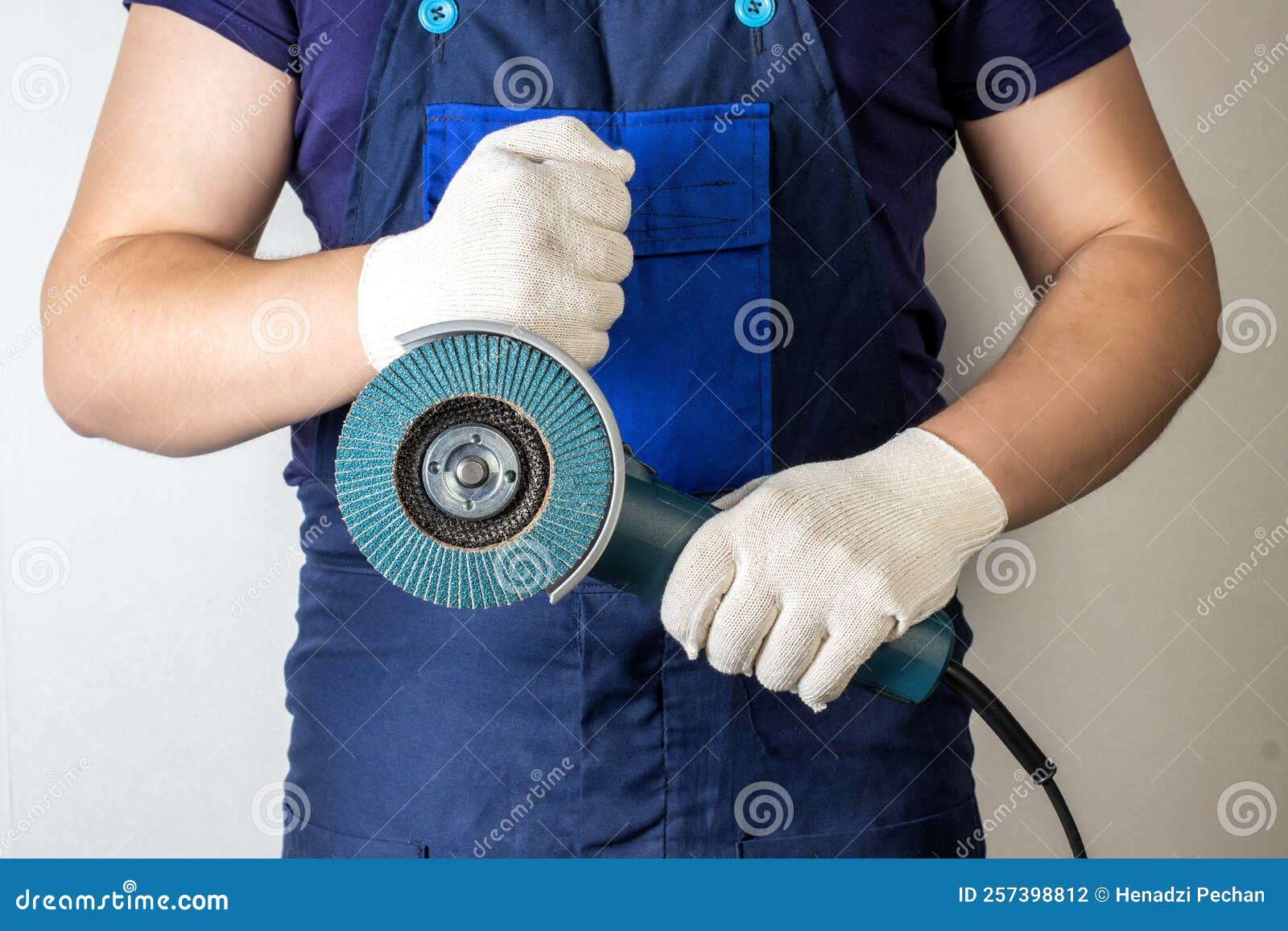 Angle Grinder in the Hands of a Working Man Against the Background of ...