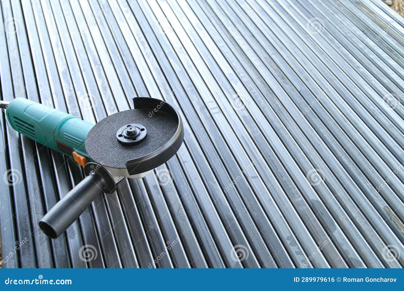 Angle Grinder on Metal Pipes. Preparing Pipes for Fence Construction ...