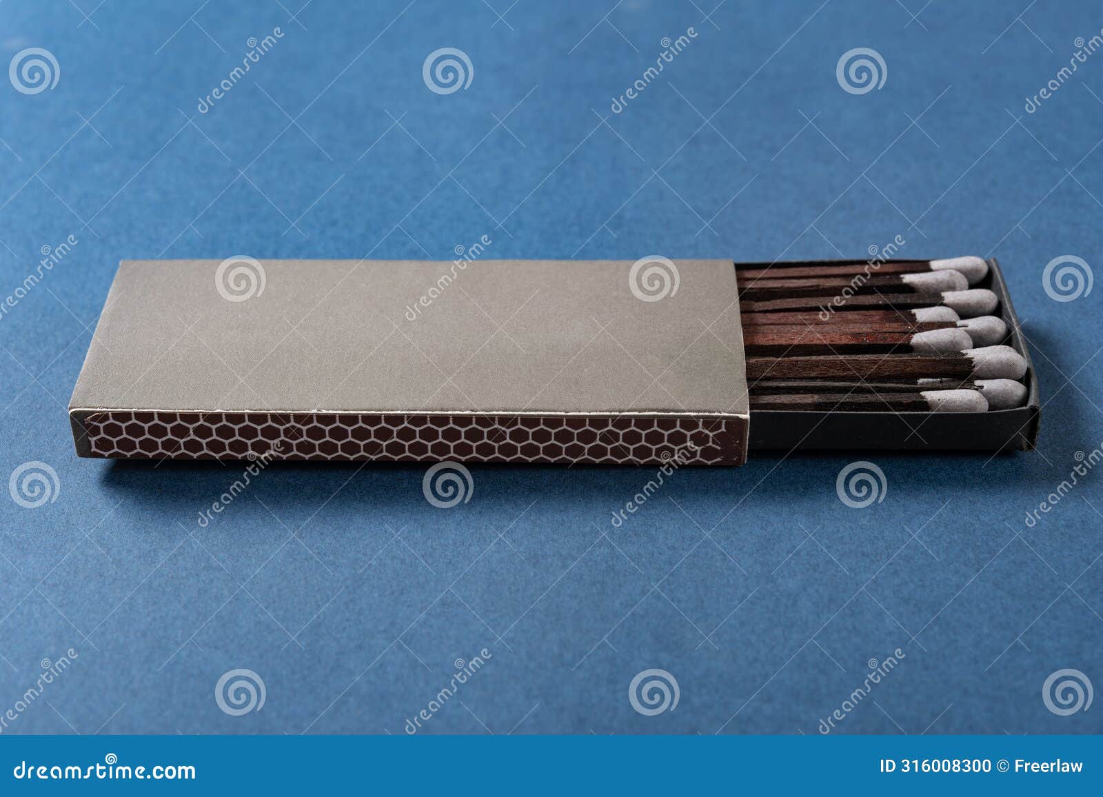 Angle View Grey Color Matchbox and Grey Match Sticks on Blue Background ...
