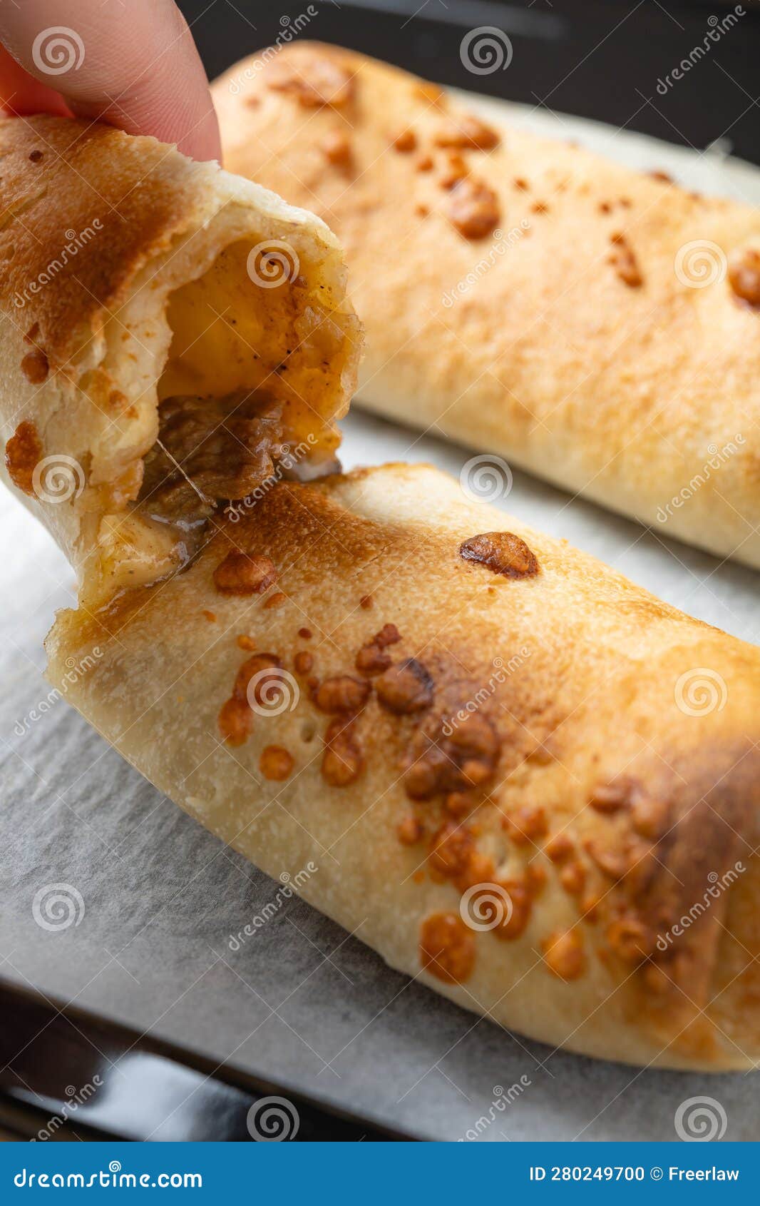 Hand with Fresh Baked Cheese Beef Roll Stock Photo - Image of angle ...