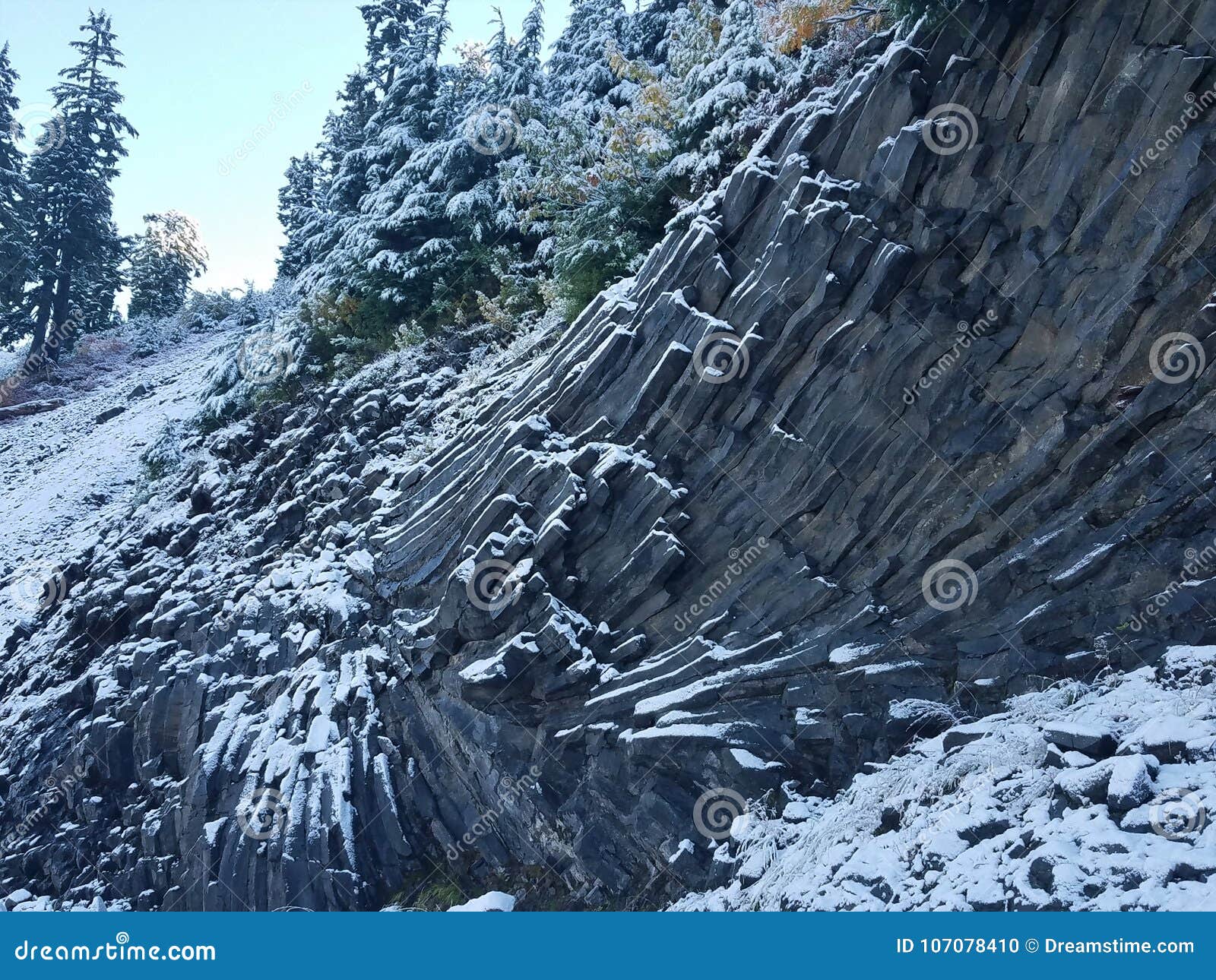 Angled Basalt Formation Covered in Snow Stock Photo - Image of ...