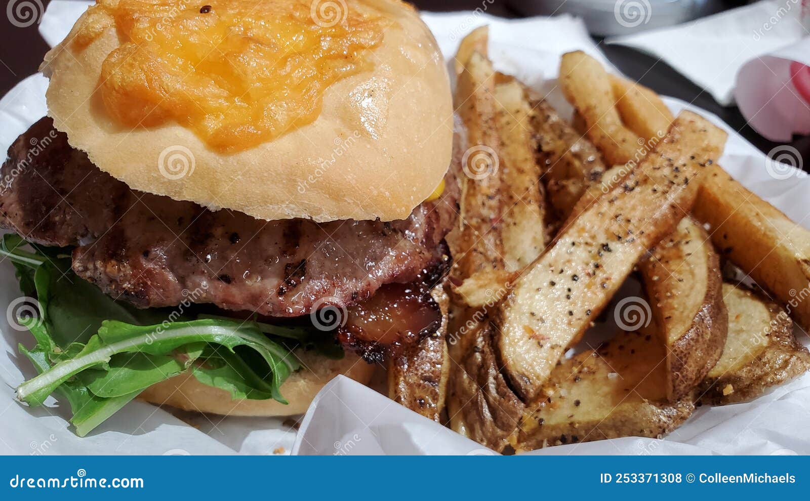 Angled Down View of a Greasy Cheeseburger and Crispy Steak Fries ...