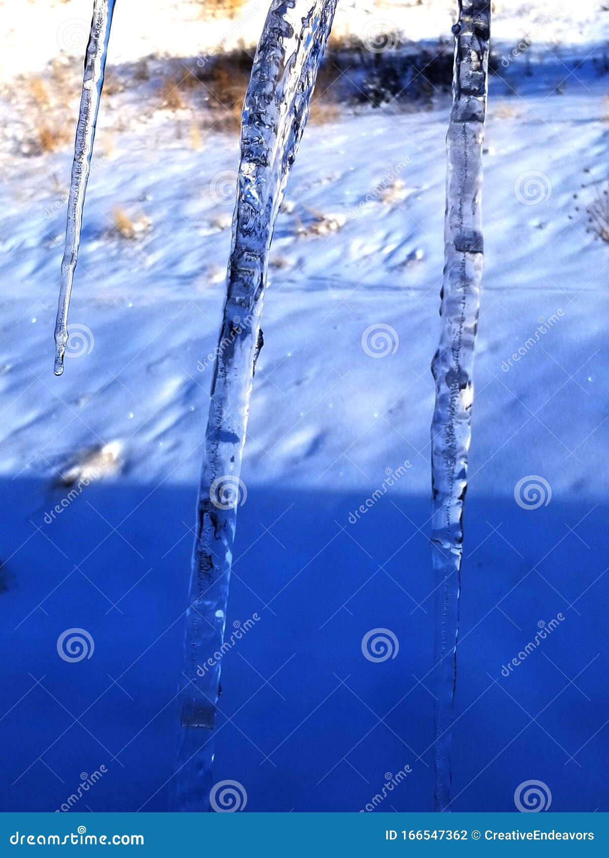 Angled Icicles on a Snowy Roof Edge Stock Photo - Image of frozen ...