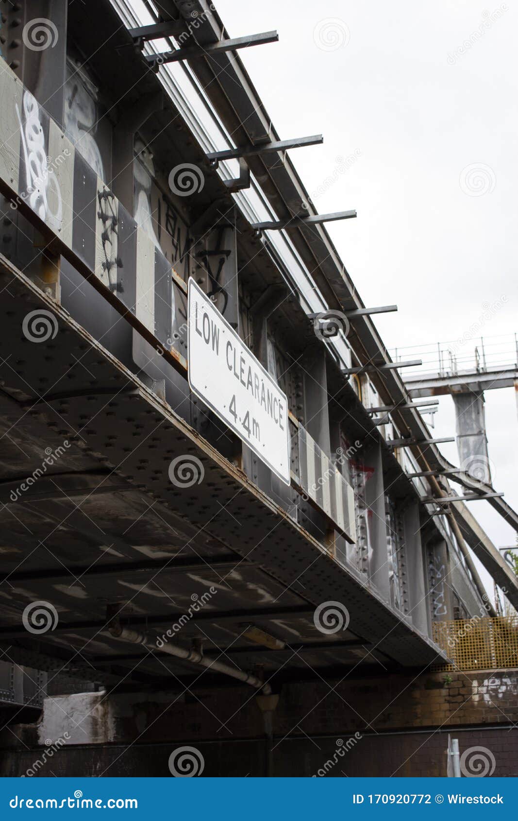 Angled Shot of a Sign on the Side of an Overpass Indicating a Low ...