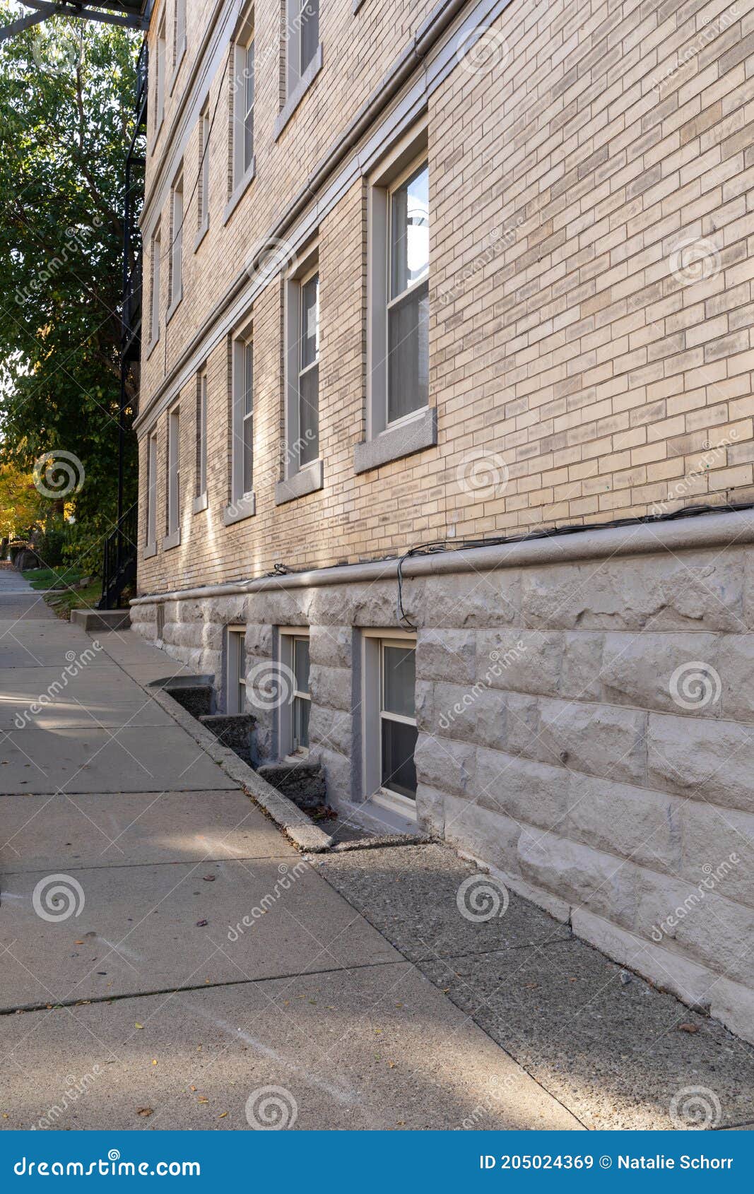 Angled View Of Inclined Sidewalk And Building Of Tan Brick And ...
