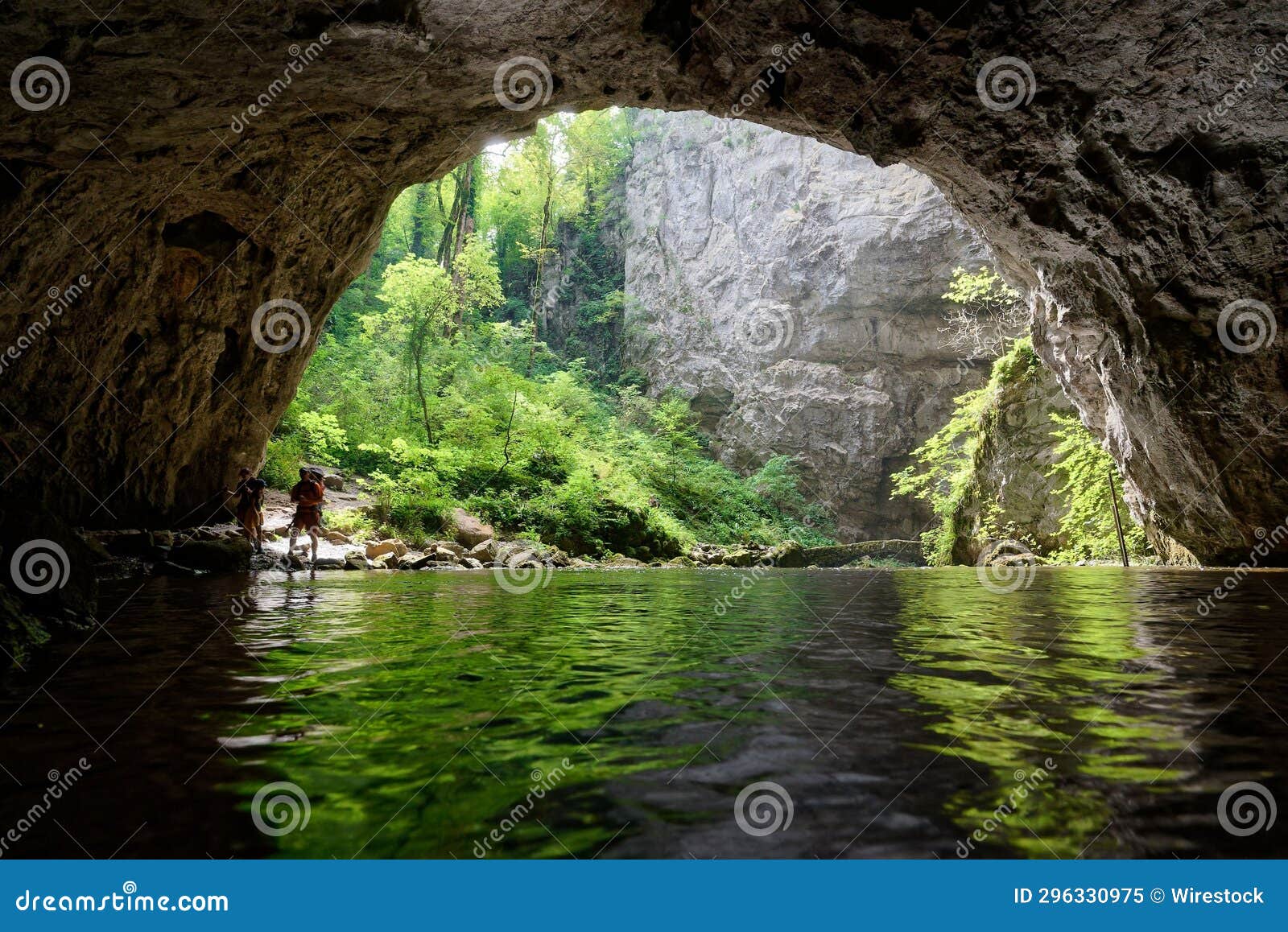 Angled View from Inside a Cave, Looking Out Towards a Lush Forest Scape ...
