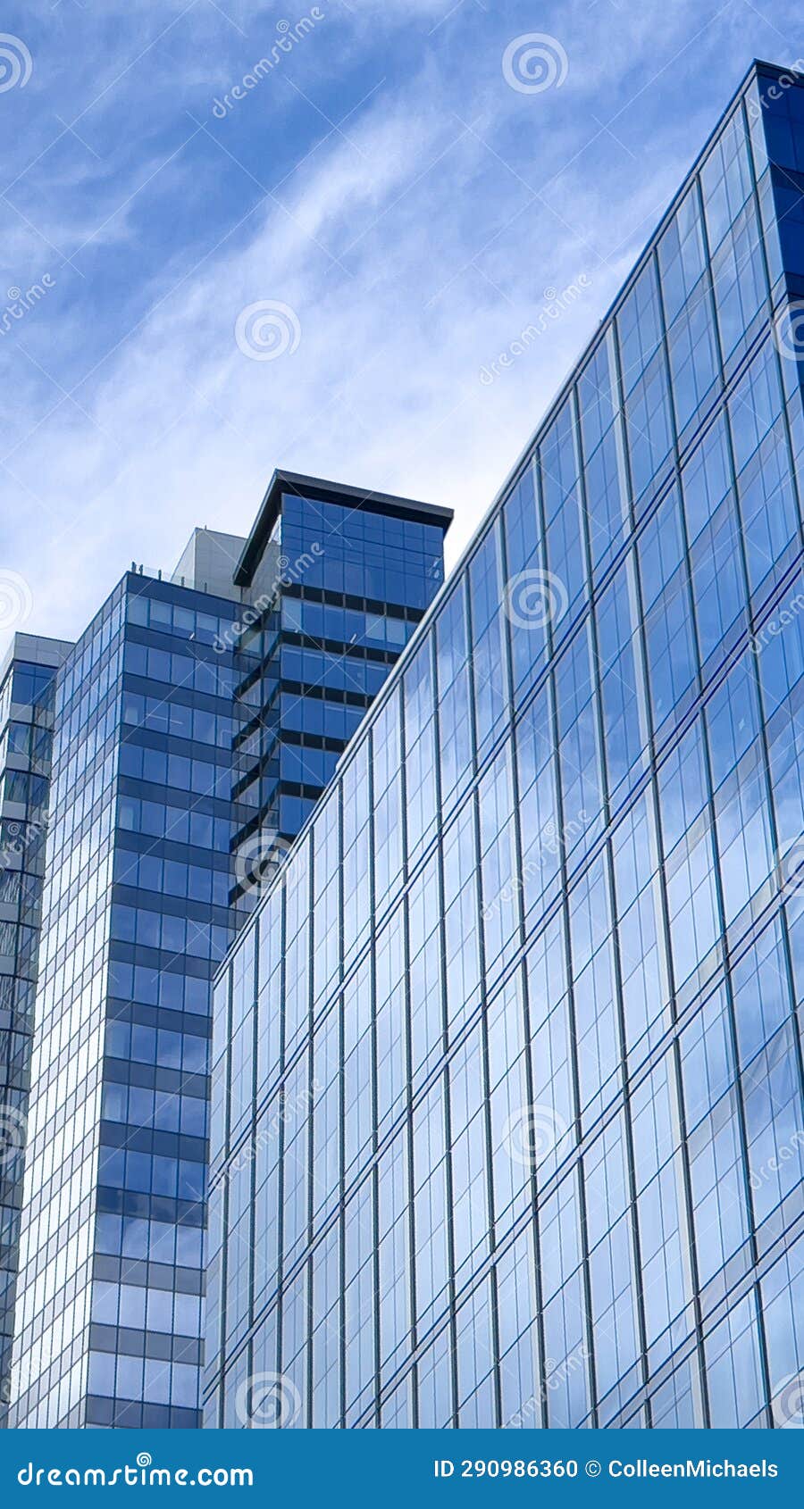 Angled View of a Large, Window Covered Building Corner Against a Blue ...