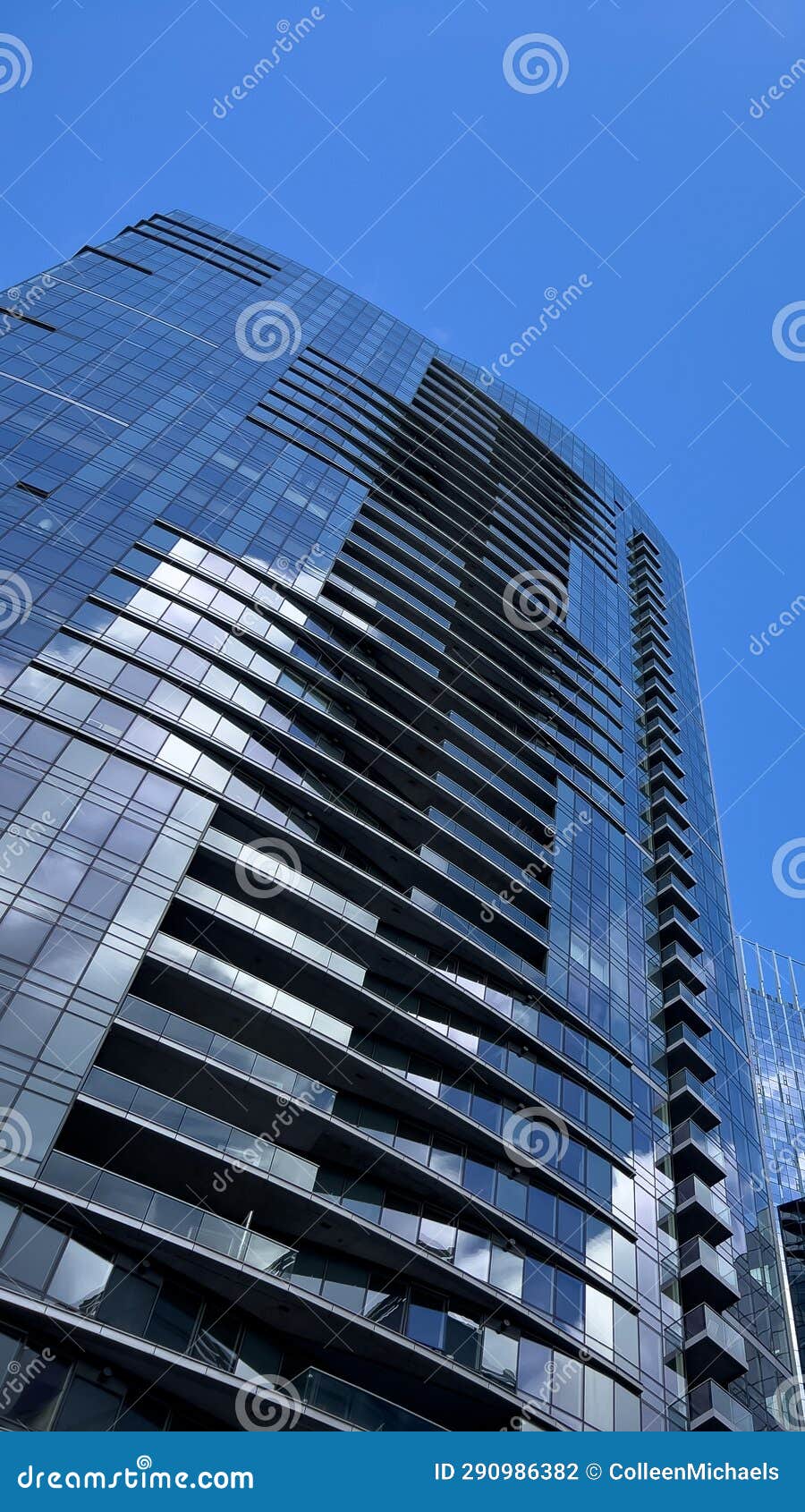 Angled View of a Large, Window Covered Building Corner Against a Blue ...