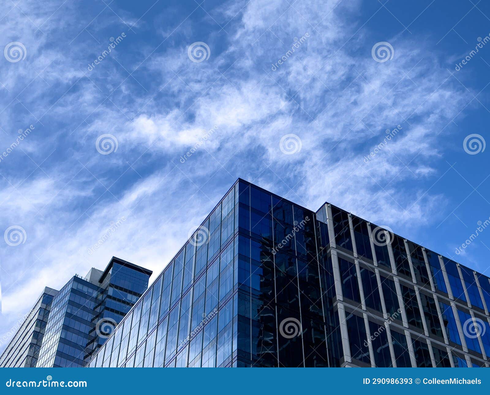 Angled View of a Large, Window Covered Building Corner Against a Blue ...