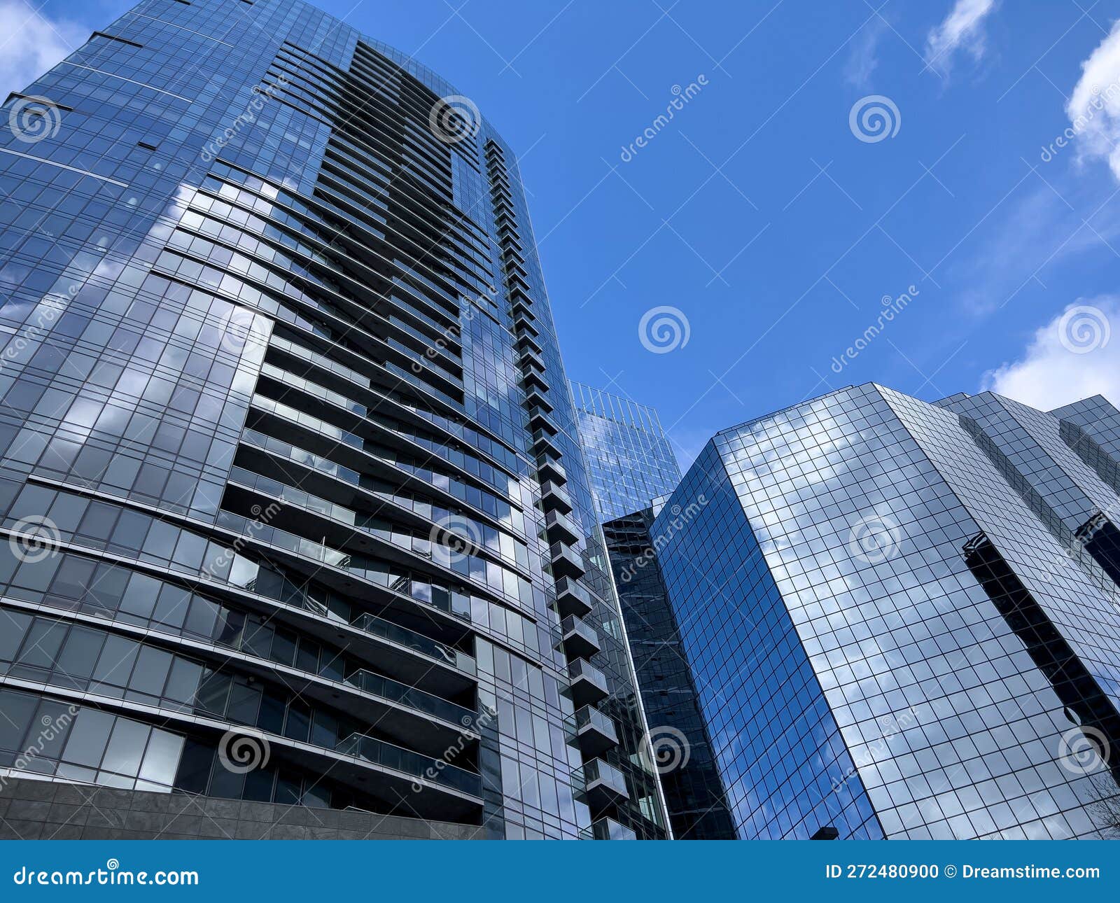 Angled View of Large, Window Covered Building Corners Against a Blue ...