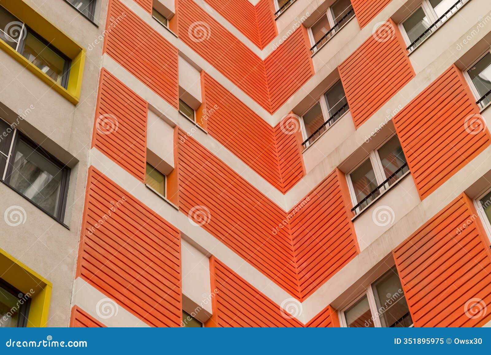 Angled View of a Modern Building Facade with Orange Cladding and ...
