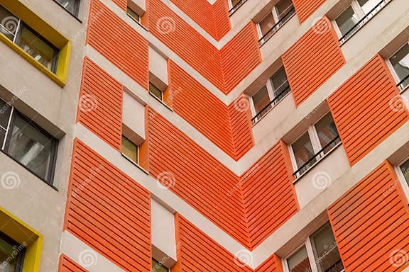 Angled View of a Modern Building Facade with Orange Cladding and ...