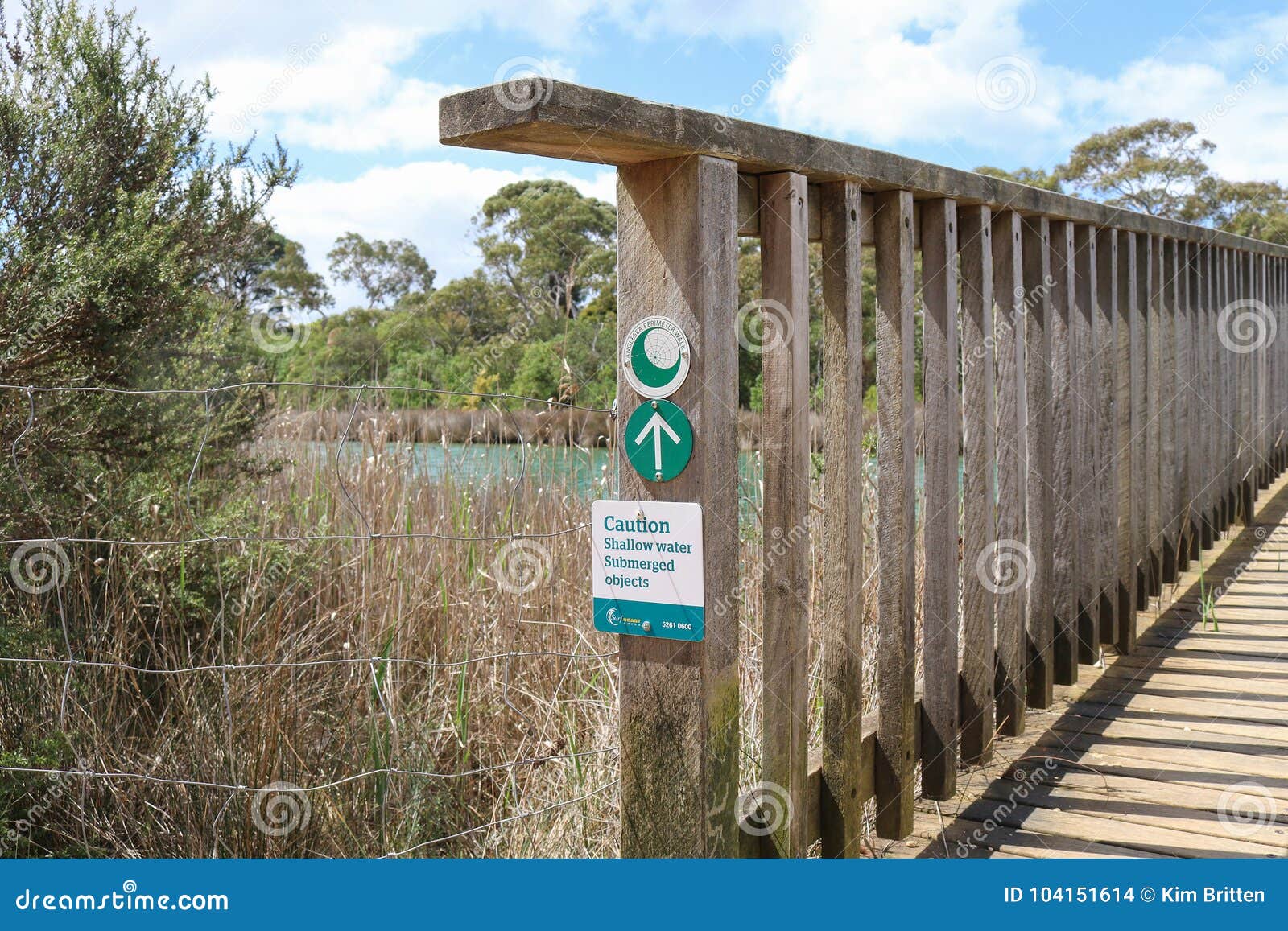 A Green and White Shallow Water Submerged Objects Warning Sign ...
