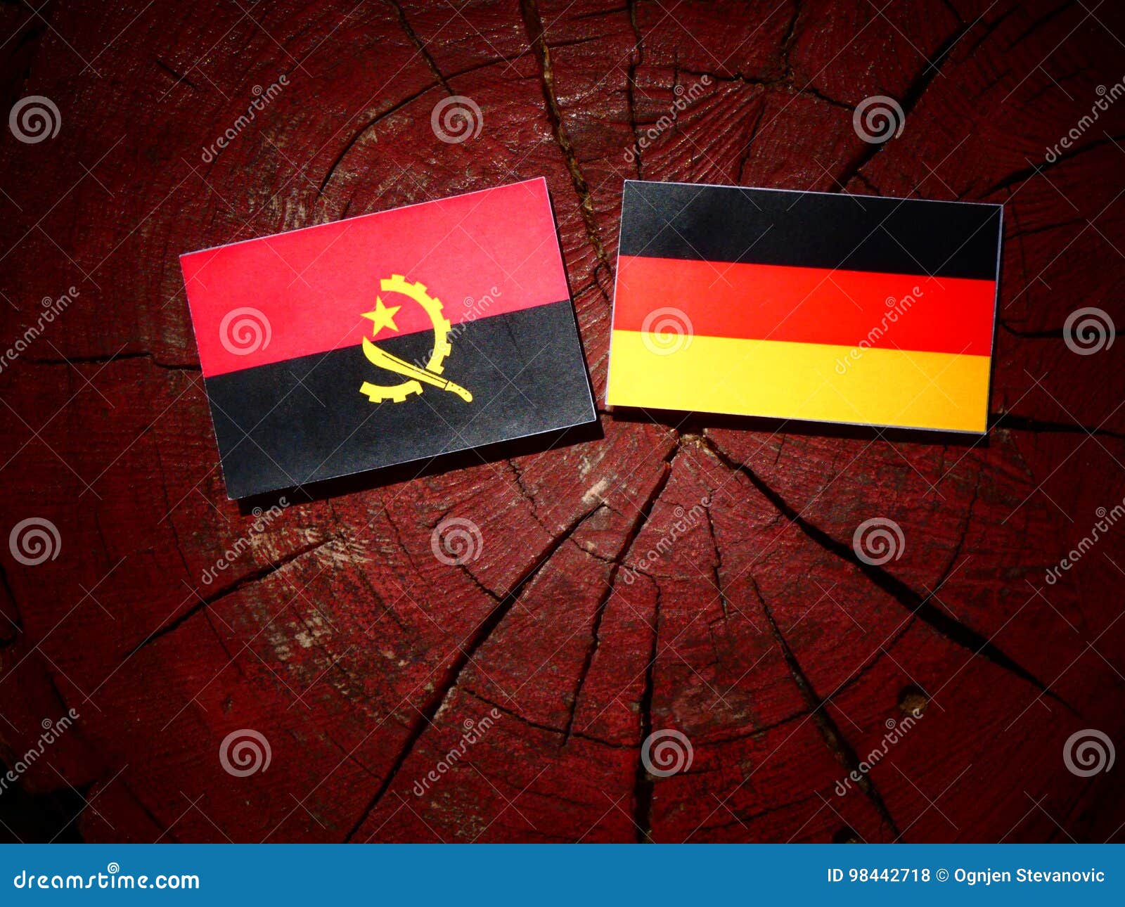 Angolan Flag with German Flag on a Tree Stump Stock Photo - Image of ...