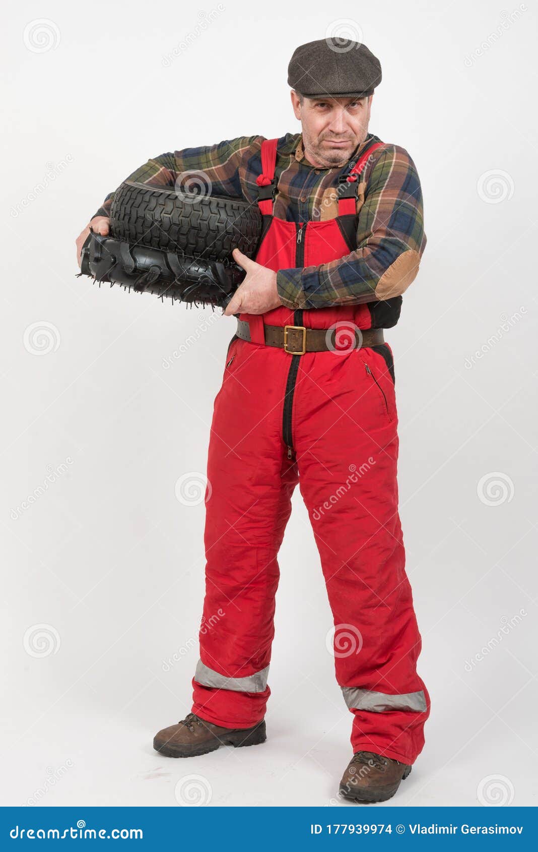 Angry Aged Man Dressed in Red Overalls Holds a Two Wheels from a ...