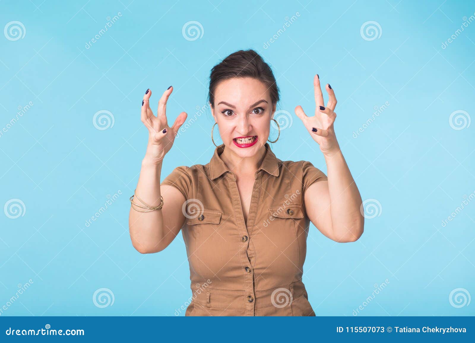 Angry Aggressive Woman with Ferocious Expression on Blue Background ...