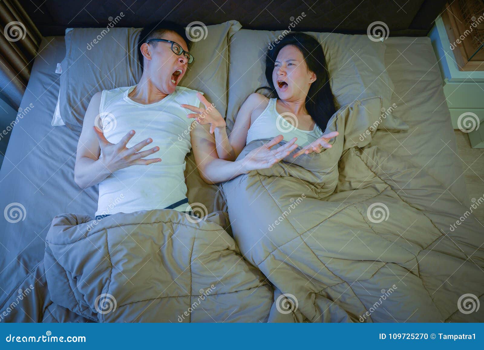 Angry Asian Couple Fighting on Bed at Night Stock Photo - Image of ...
