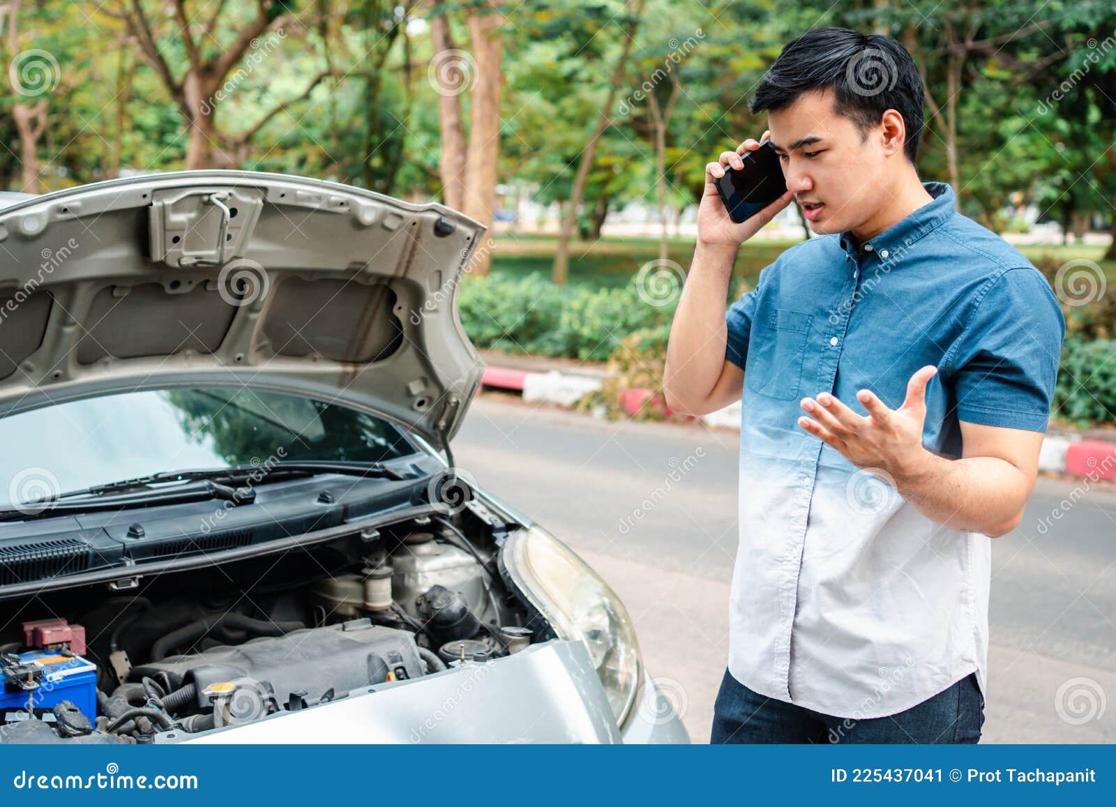 Angry Asian Man and Using Mobile Phone Calling for Assistance after a ...