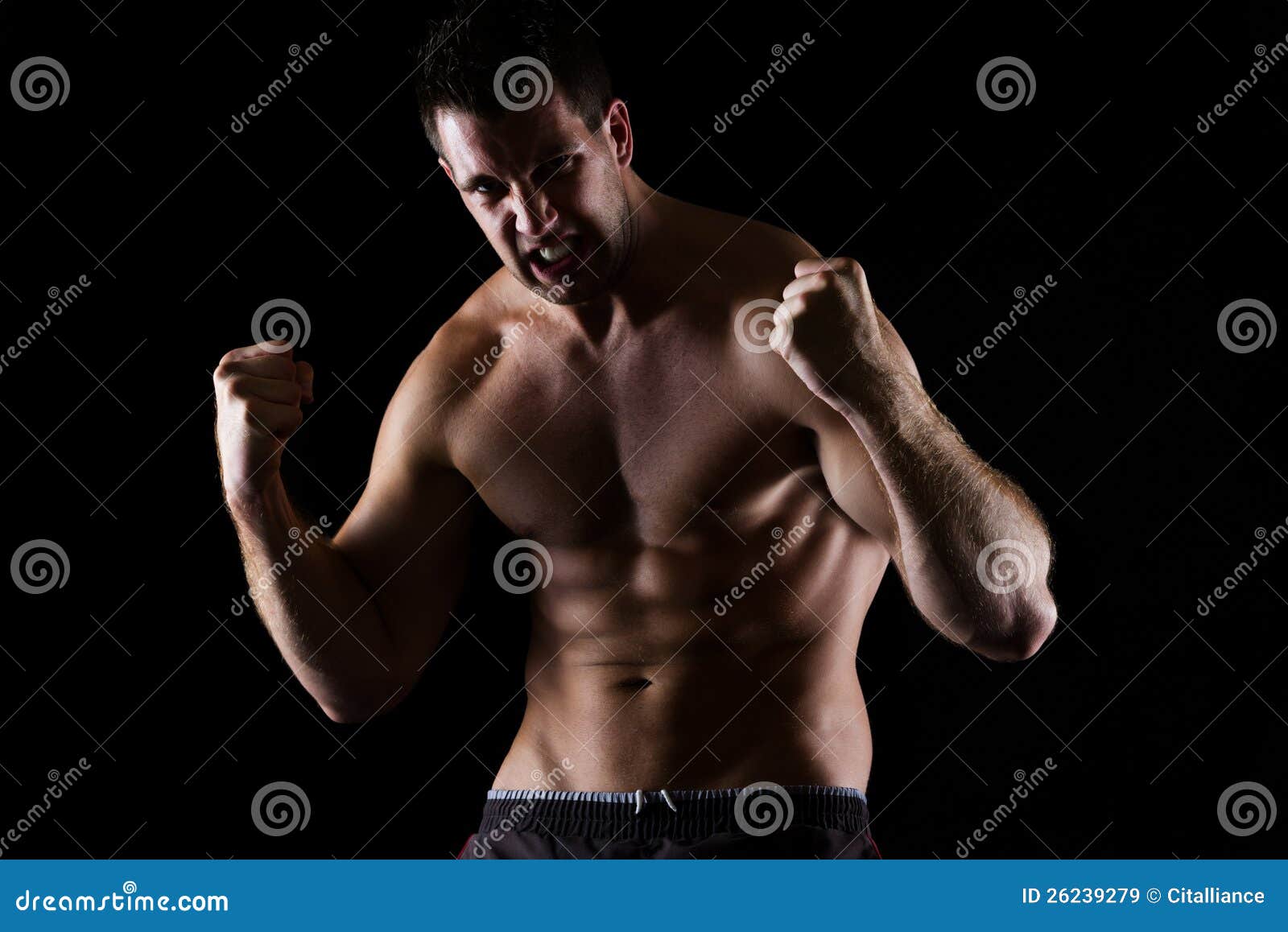 Angry Athletic Man in Attack Pose on Black Stock Image - Image of ...