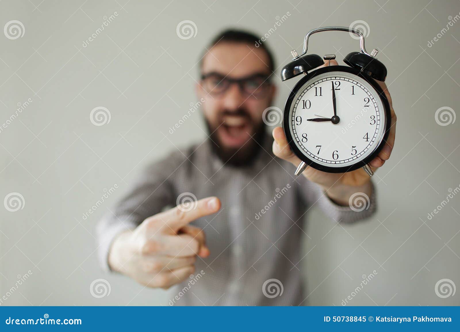 Angry Boss with Beard Holds Alarm Clock Screaming on Camera Stock Image ...