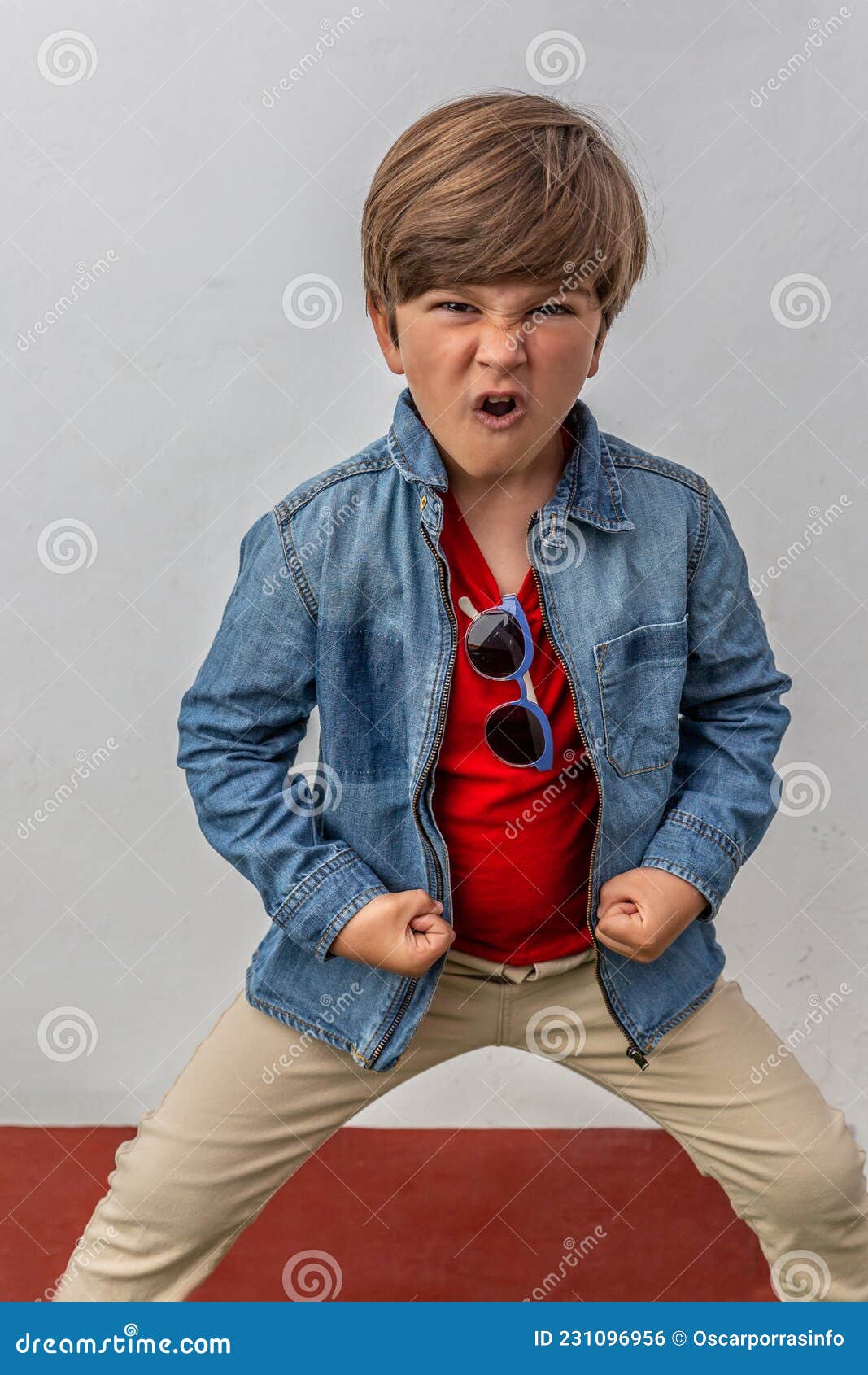 Angry Boy with Blue Denim Jacket in Front of a Wall Stock Photo - Image ...