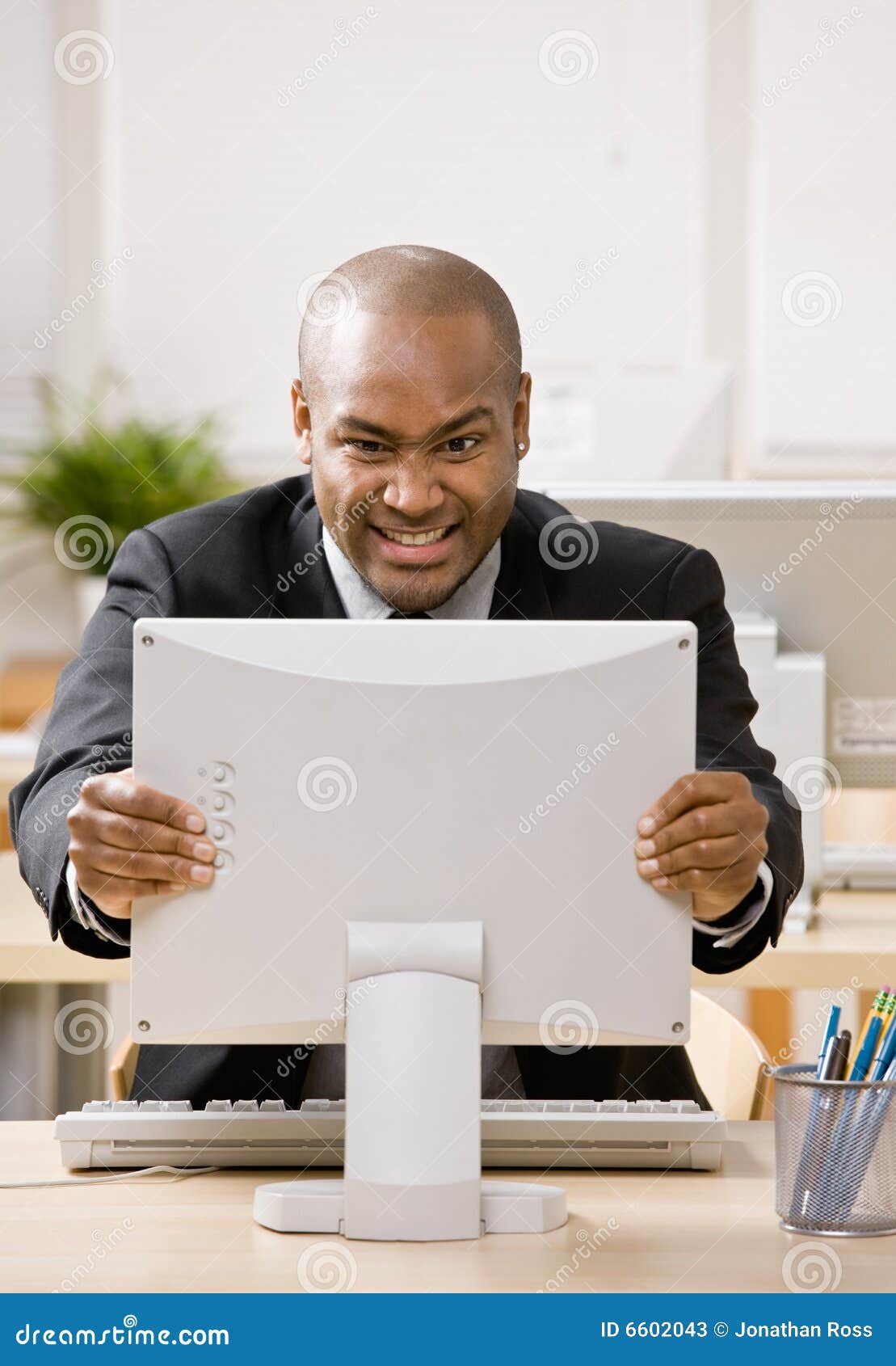 Angry Businessman Grimacing at Computer Monitor Stock Image - Image of ...