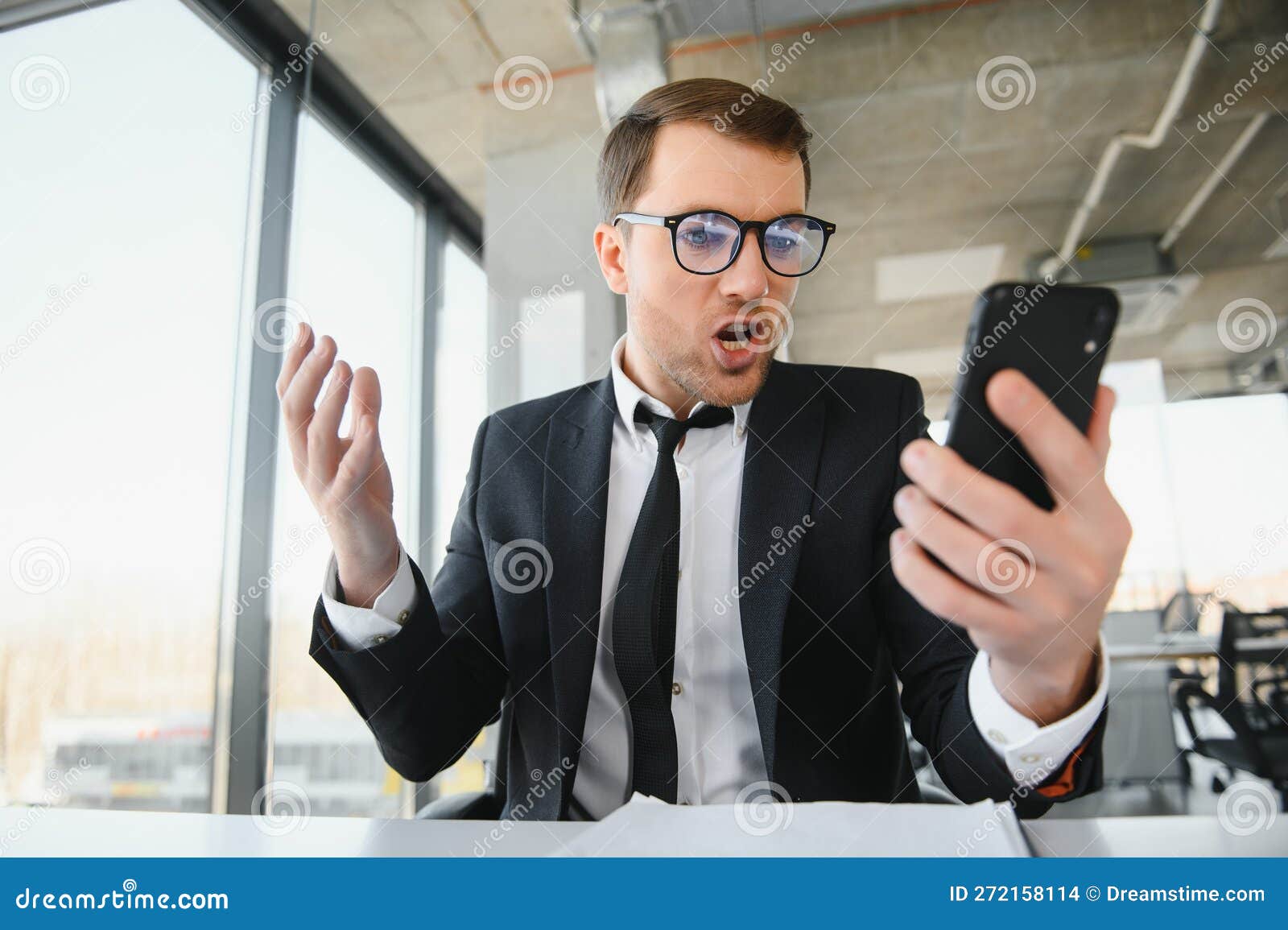 Angry Businessman Sitting at the Table and Screaming. Stock Photo ...
