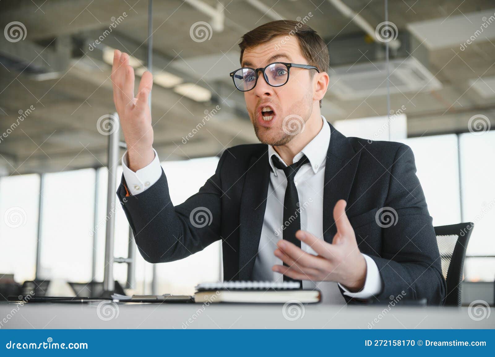Angry Businessman Sitting at the Table and Screaming. Stock Photo ...