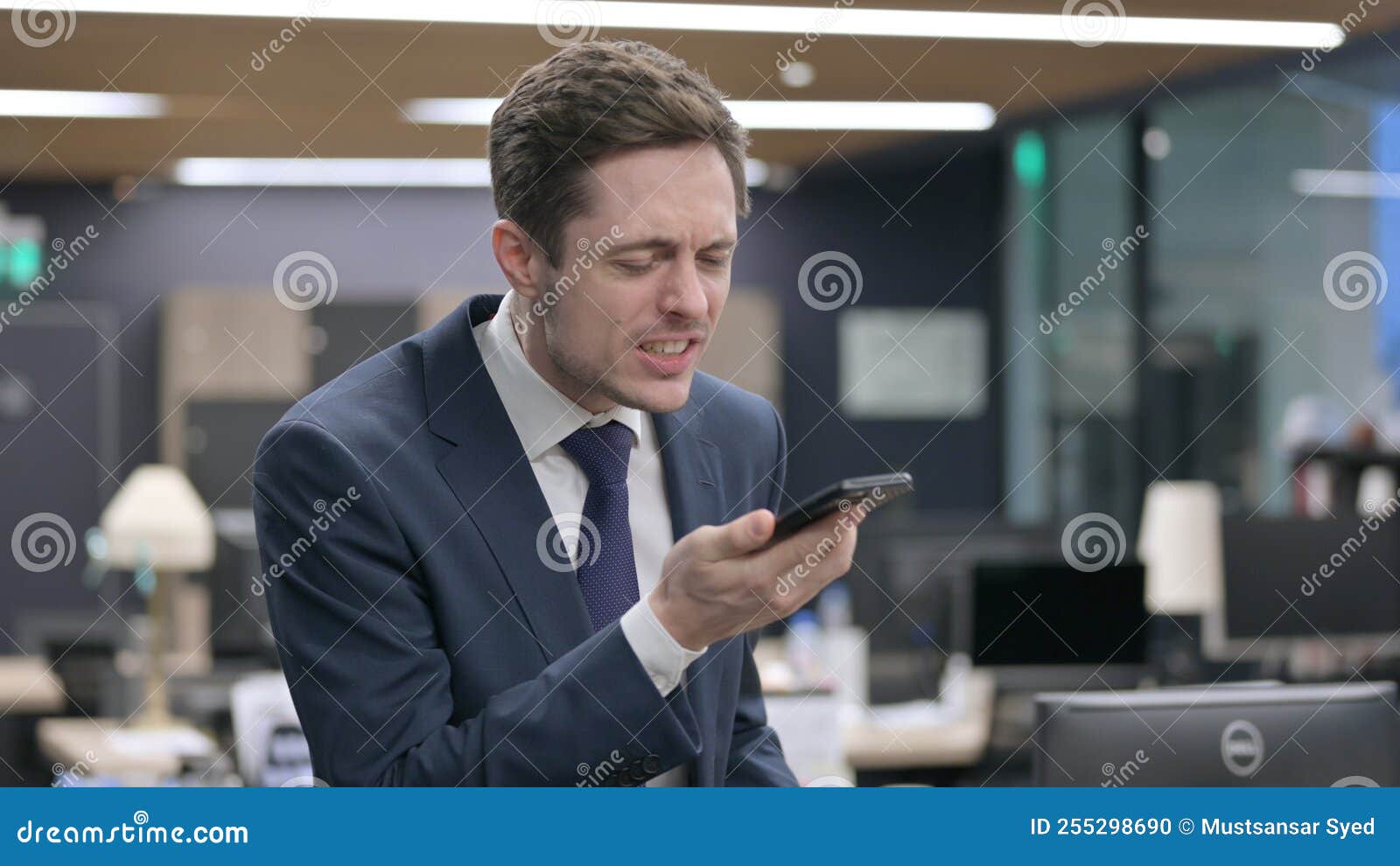 Angry Businessman Talking on Smartphone in Office Stock Photo - Image ...