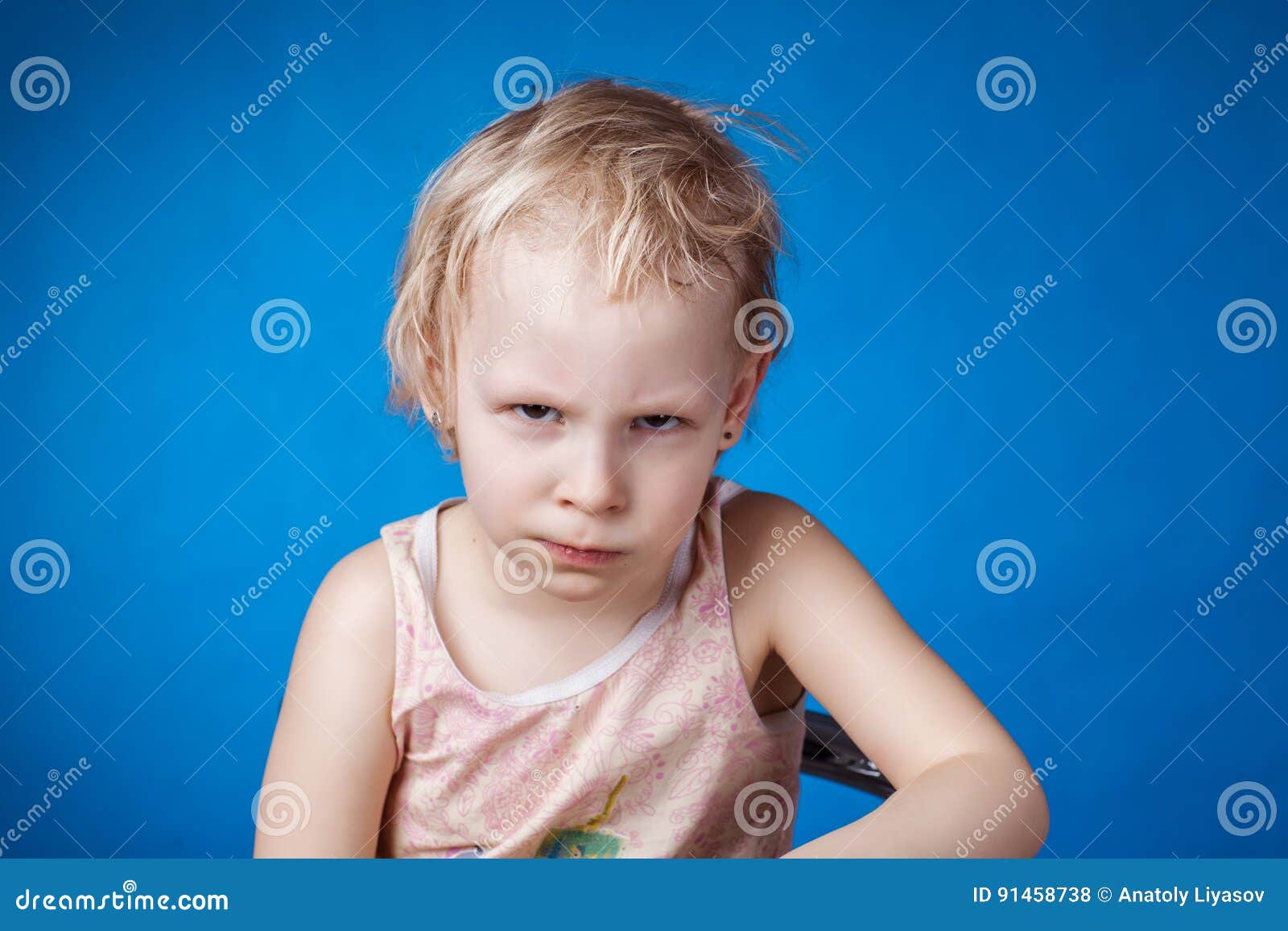 Angry Child on a Blue Background Stock Photo - Image of front, girls ...