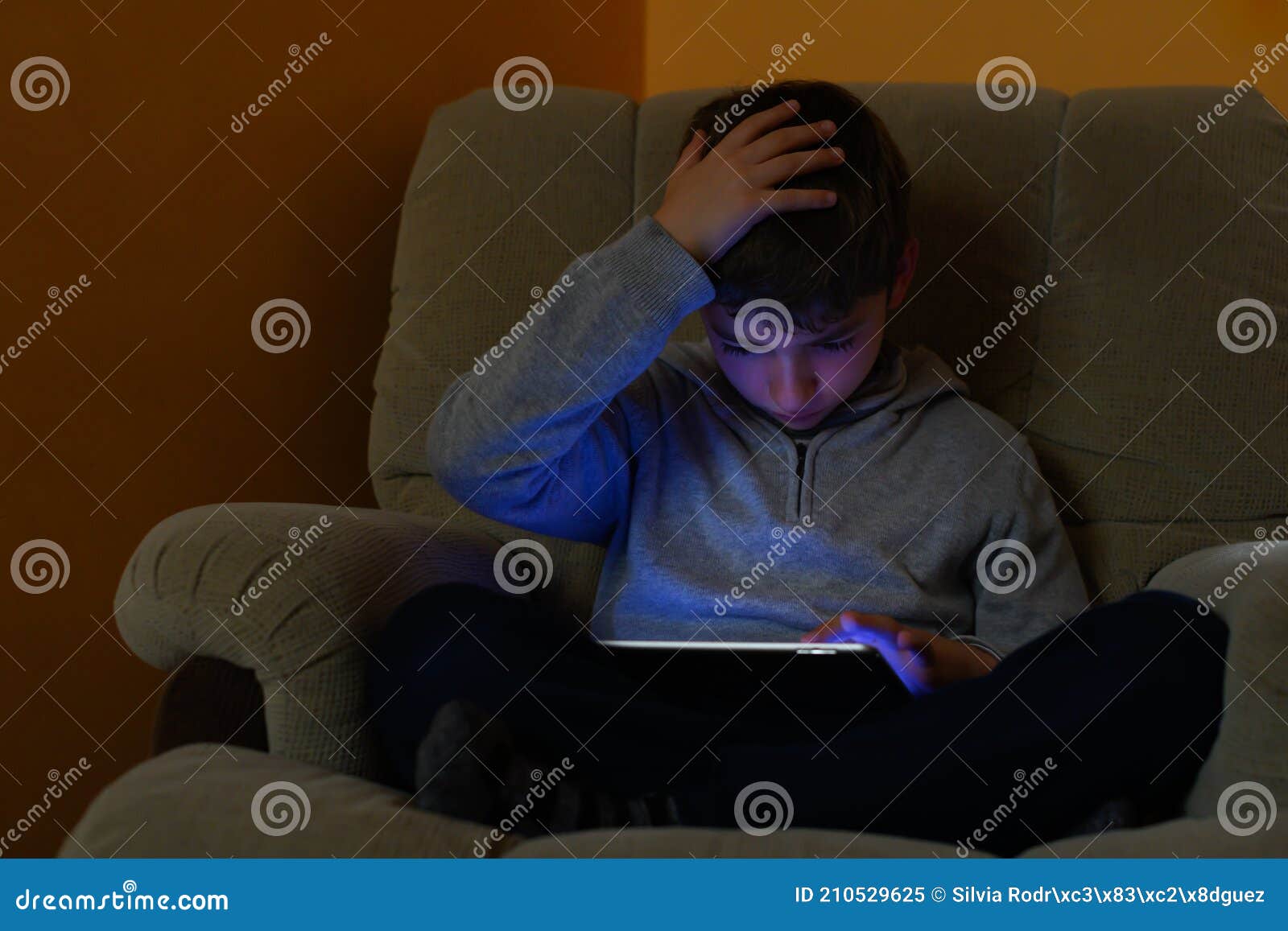 Angry Child Sitting Looking at the Tablet Stock Image - Image of indoor ...
