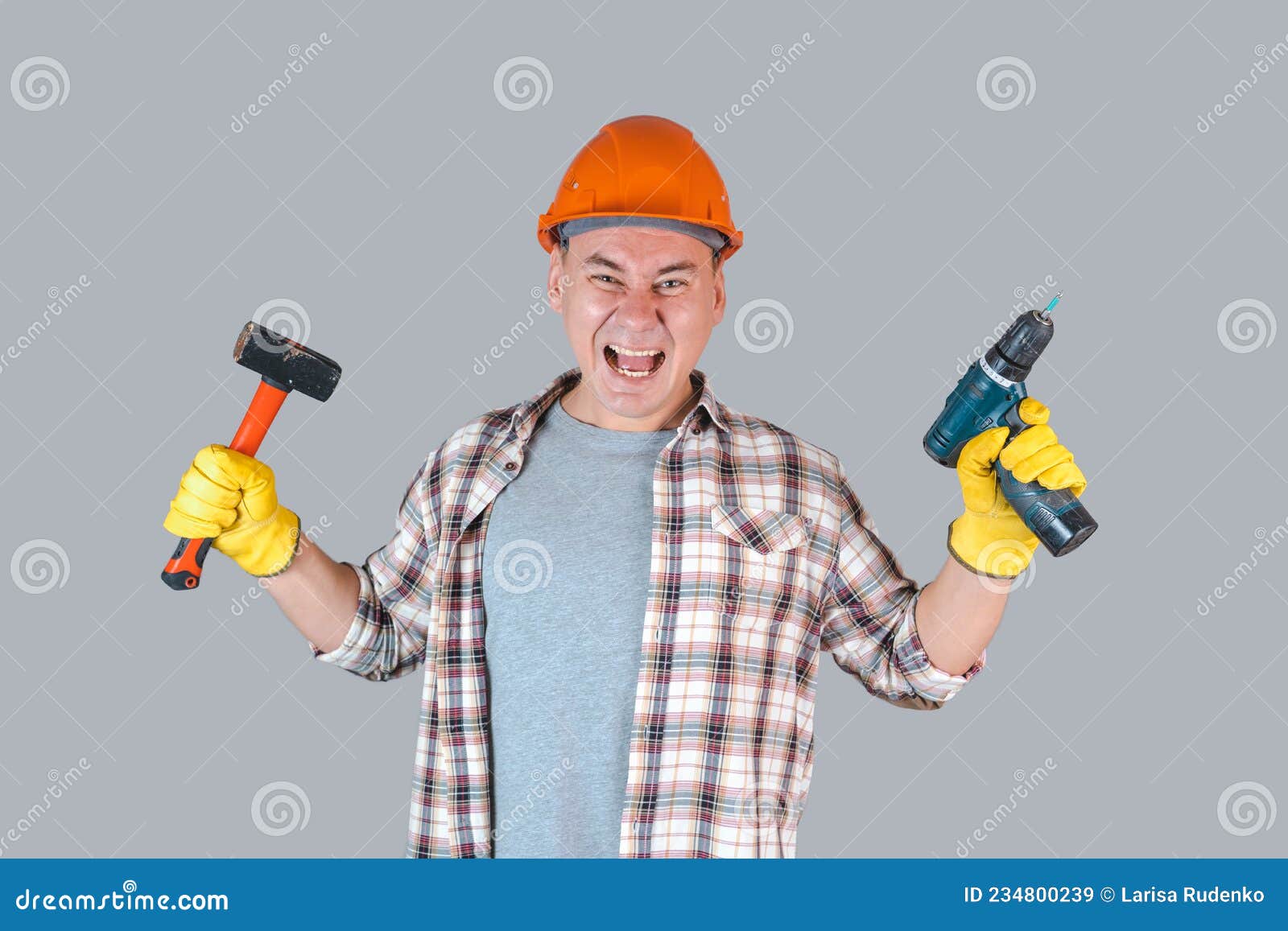 An Angry Construction Worker in Hardhat Screams with a Tool in His ...