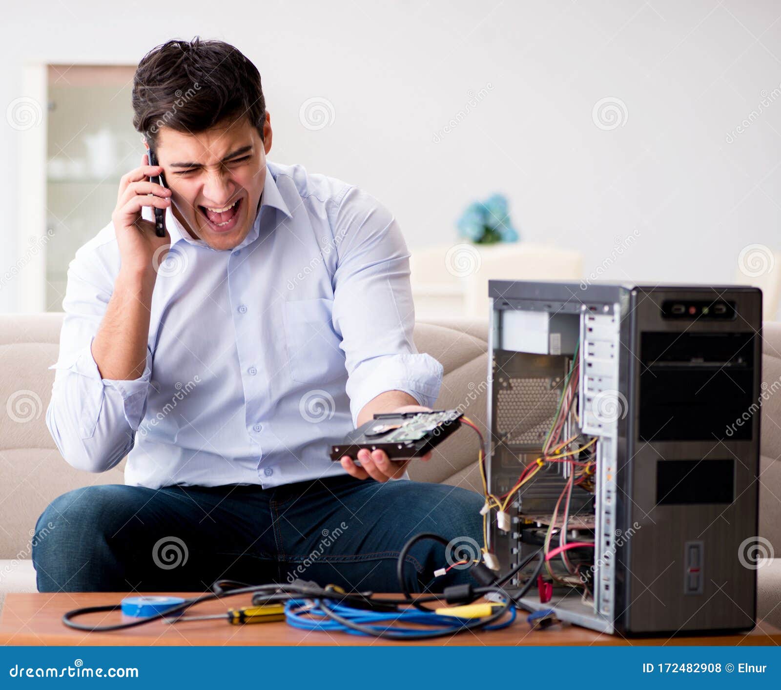 Angry Customer Trying To Repair Computer with Phone Support Stock Photo ...
