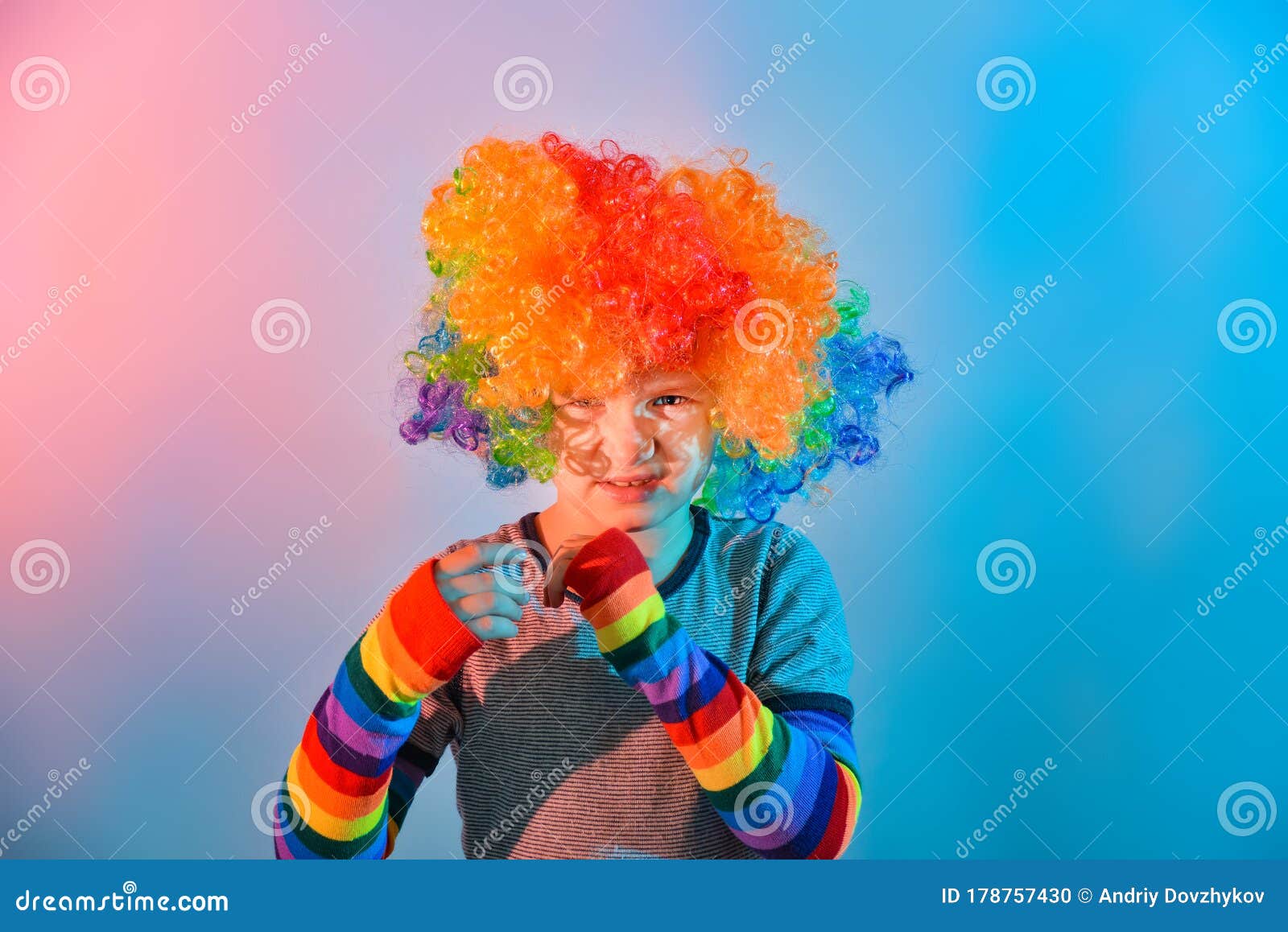 Angry and Displeased Boy in a Clown Wig and Multi-colored Sleeves Stock ...