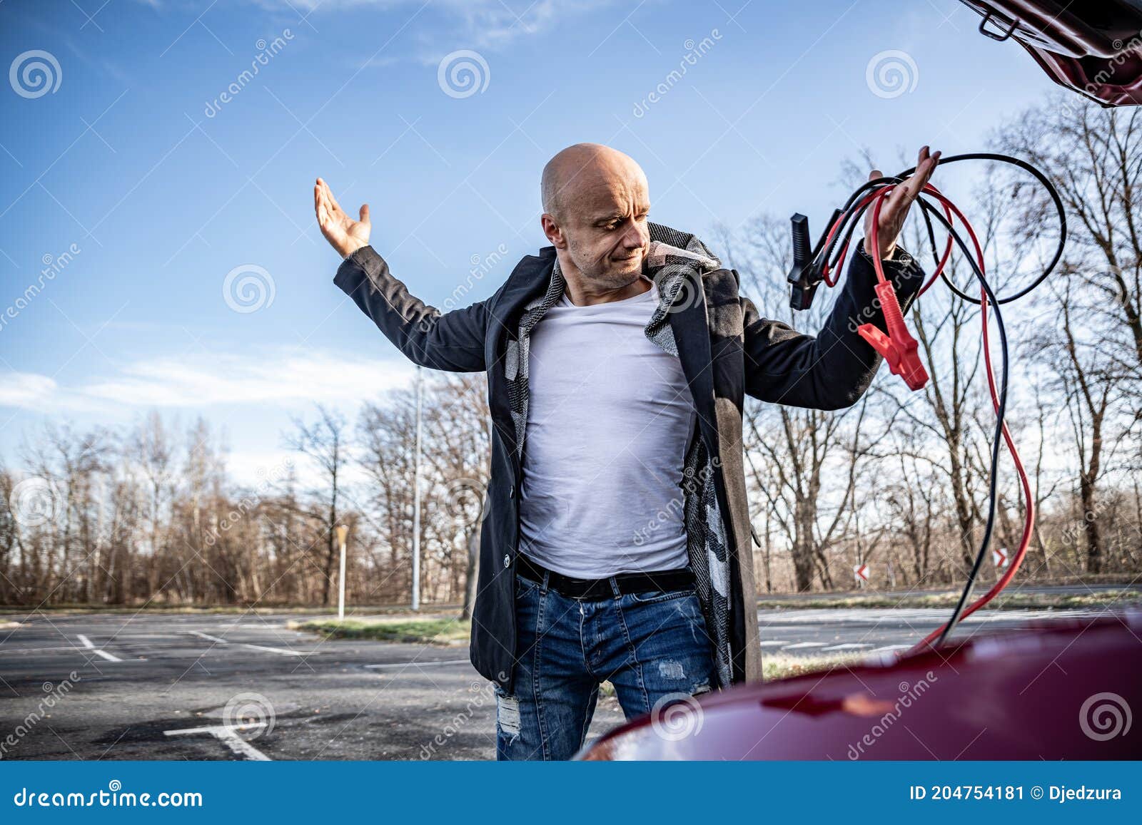 Angry Driver Trying To Start Broken Car with Jumper Cables Stock Image ...