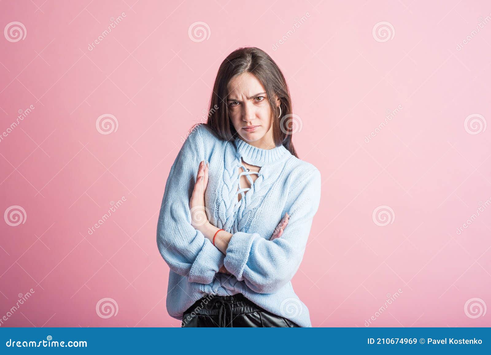 Angry Emotions of a Brunette Girl in the Studio on a Pink Background ...